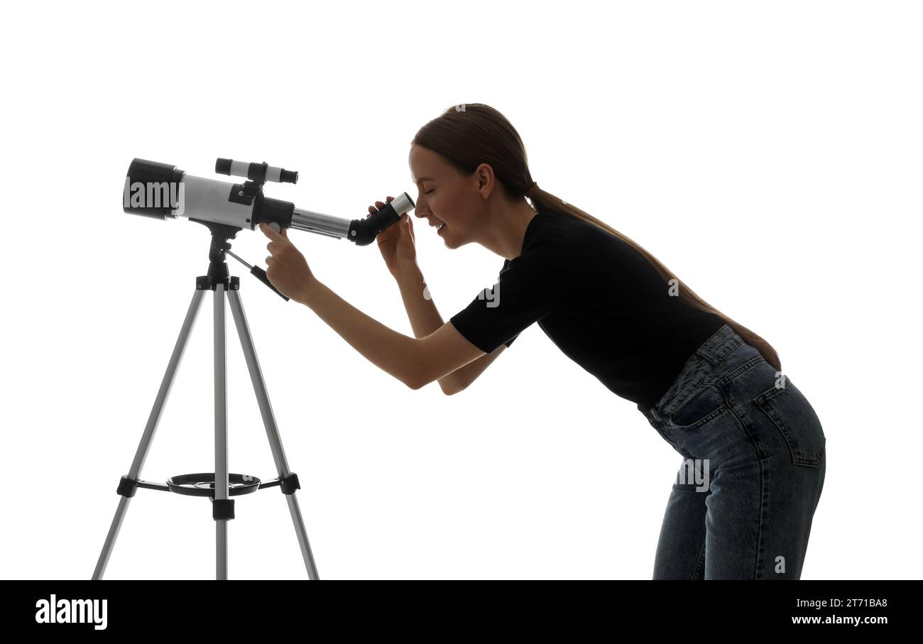 Young astronomer looking at stars through telescope on white background ...