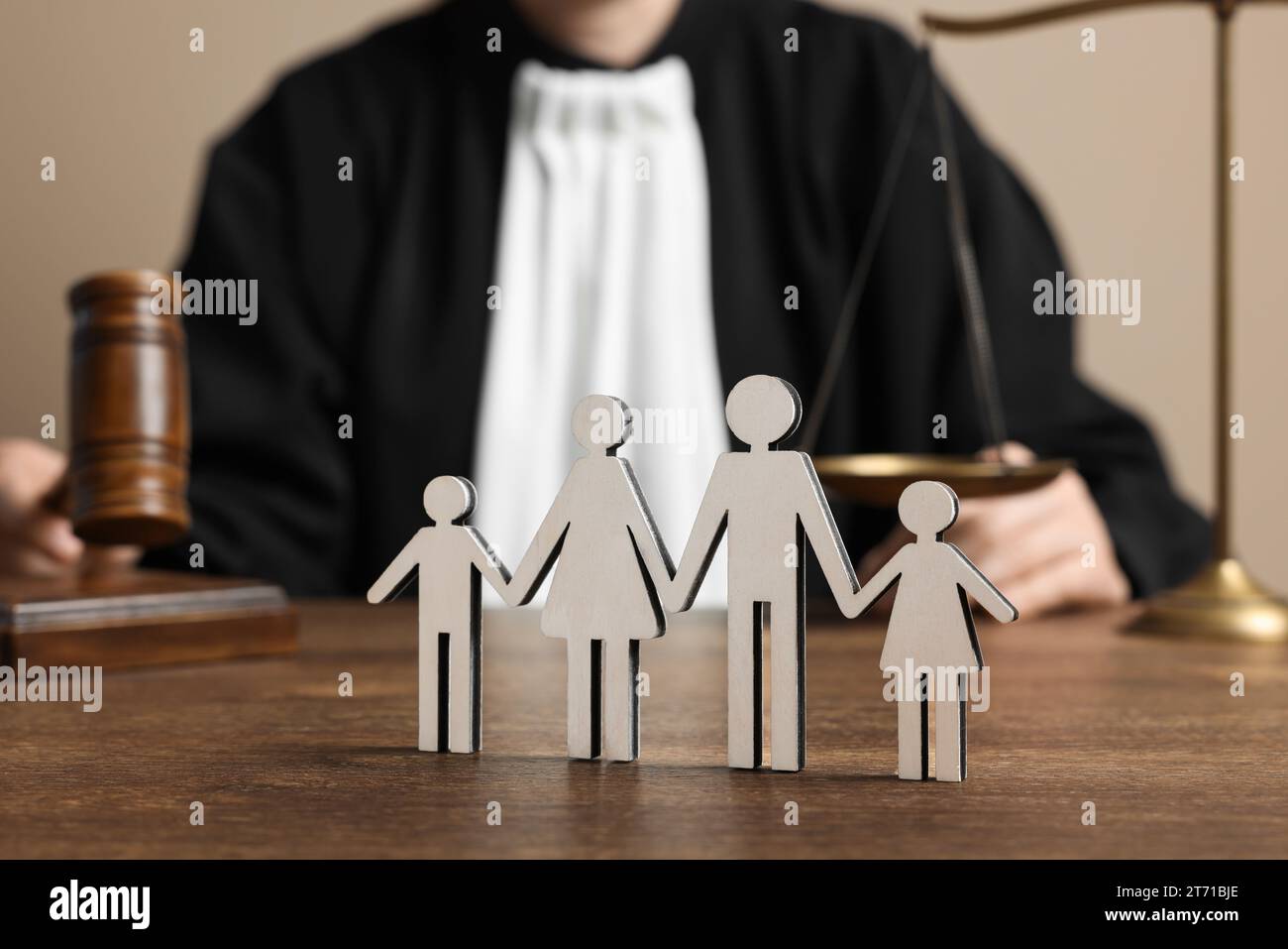 Family law. Judge with gavel and scales of justice sitting at wooden ...