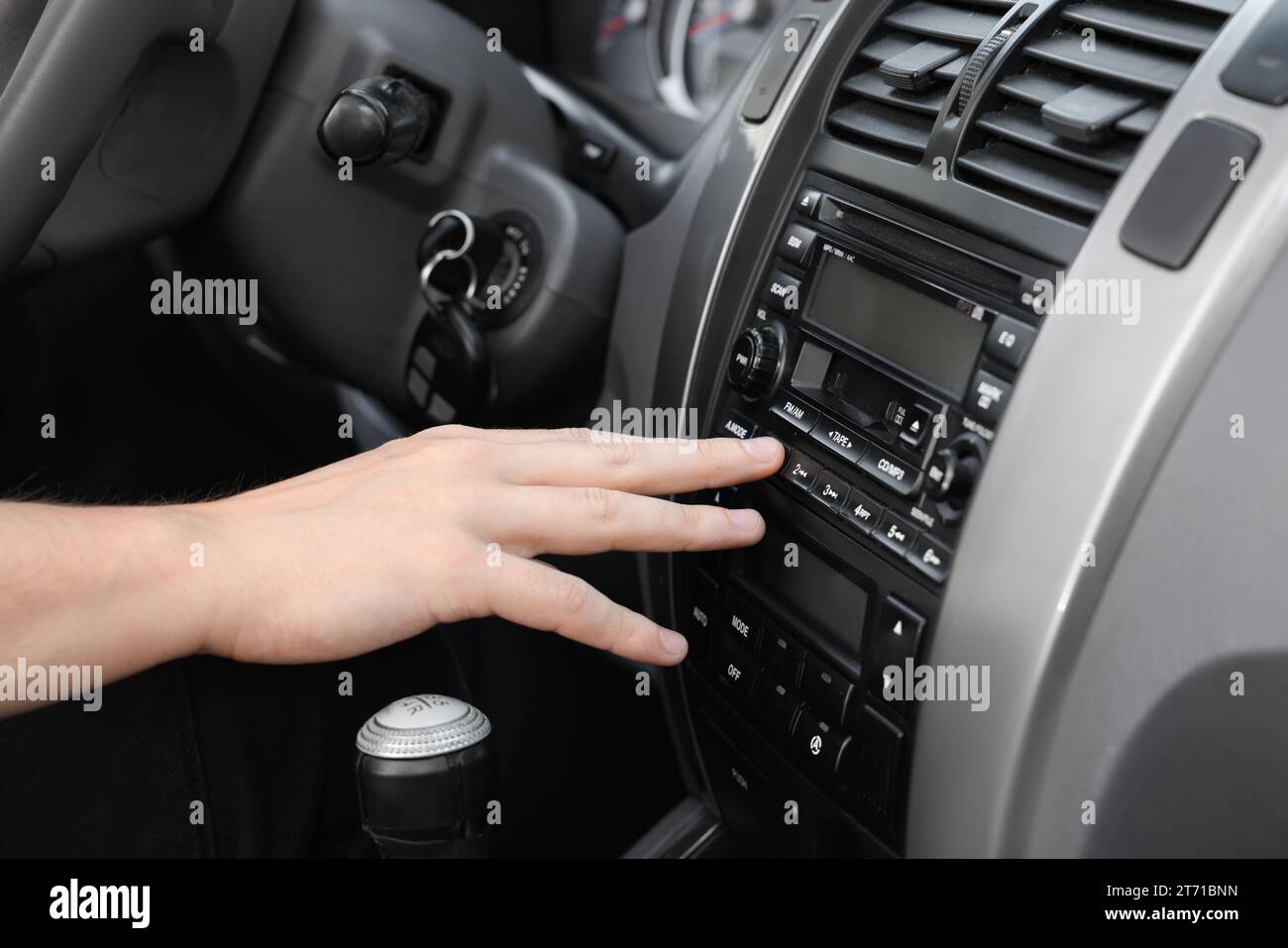 Choosing favorite radio. Woman pressing button on vehicle audio in car ...