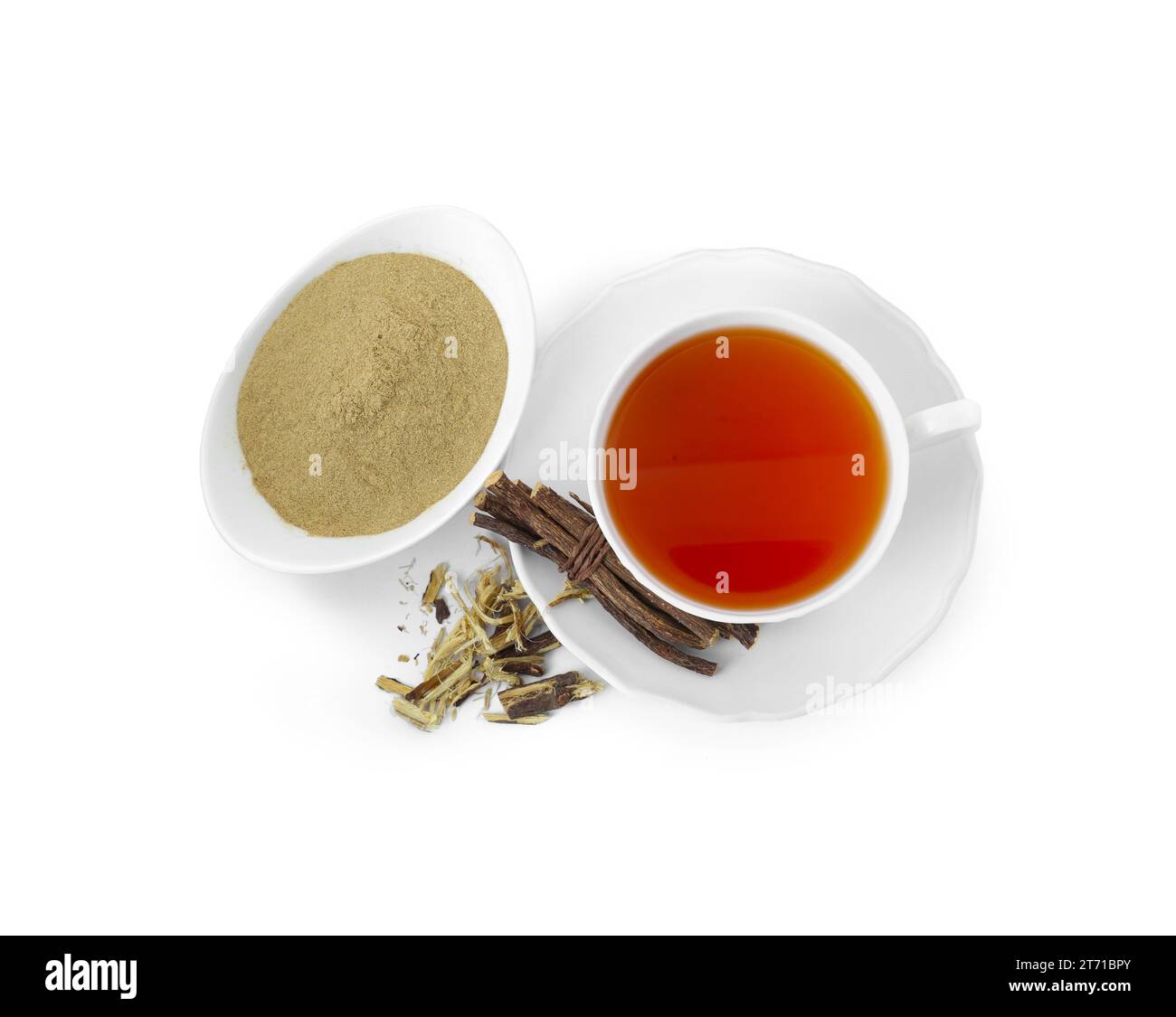 Aromatic licorice tea in cup, dried sticks of licorice root and powder ...