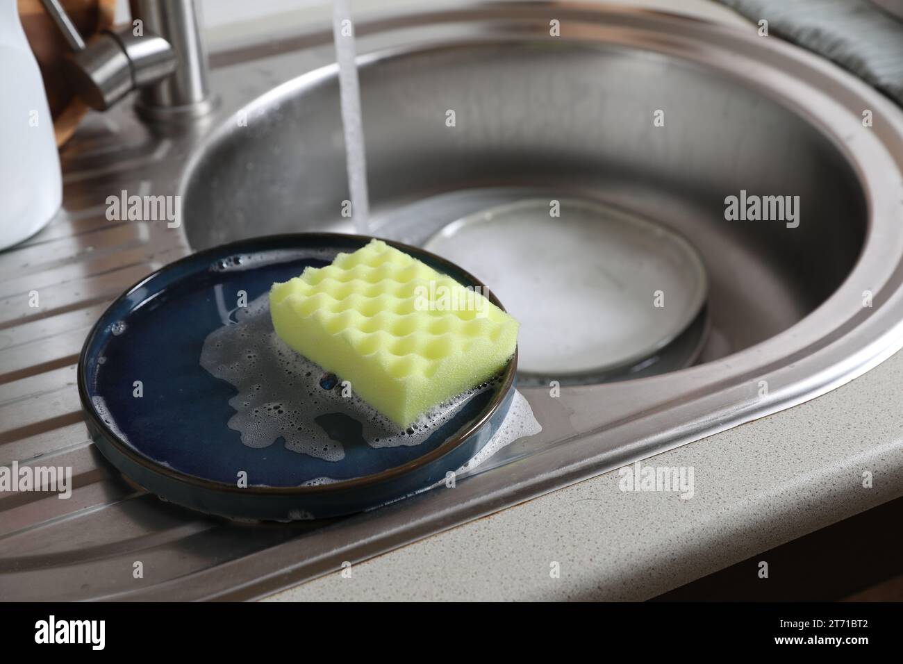 Plates and sponge in kitchen sink. Washing dishes Stock Photo - Alamy
