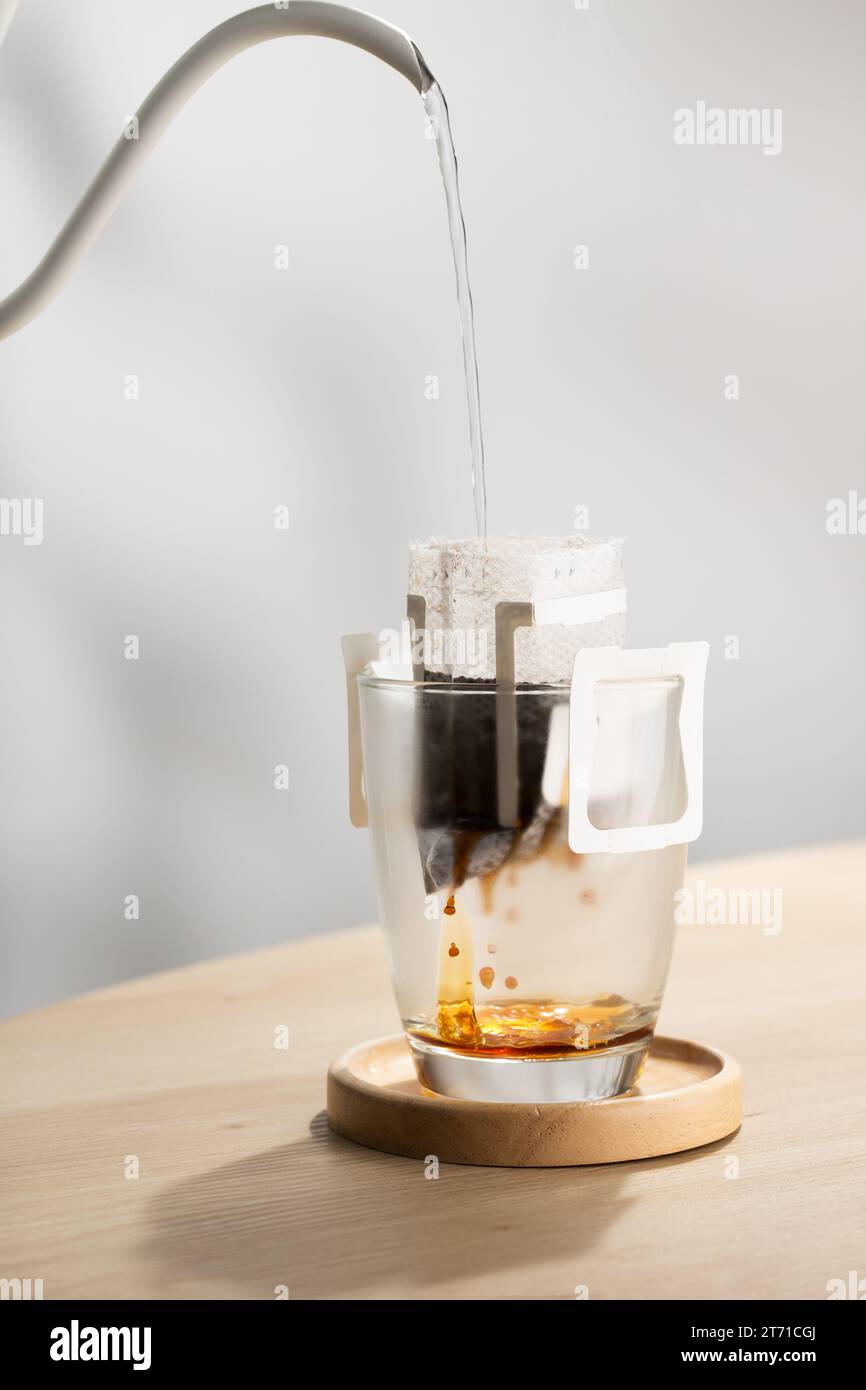 The hot water is poured over the roasted and ground coffee, in a filter ...
