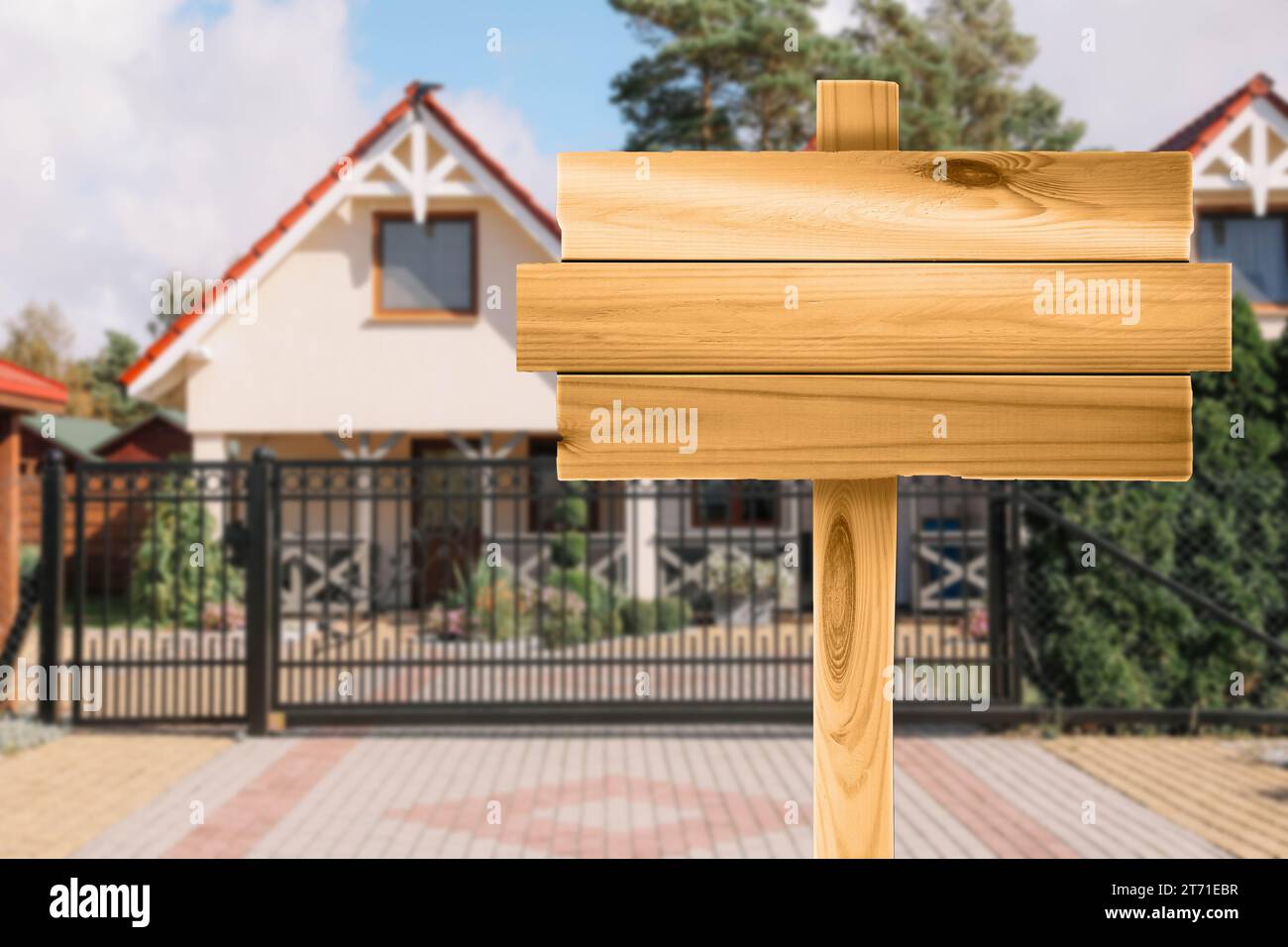 Empty wooden sign near beautiful house outdoors Stock Photo - Alamy
