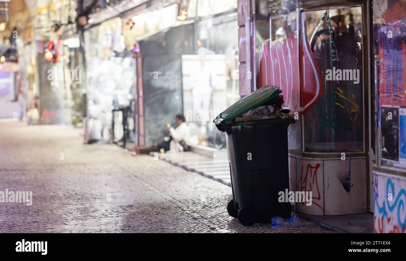 A trash can sitting on the side of a street Stock Photo - Alamy