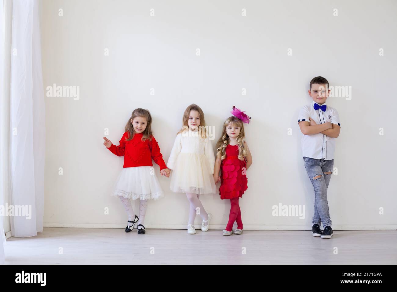 four children standing in a bright holiday room Stock Photo - Alamy
