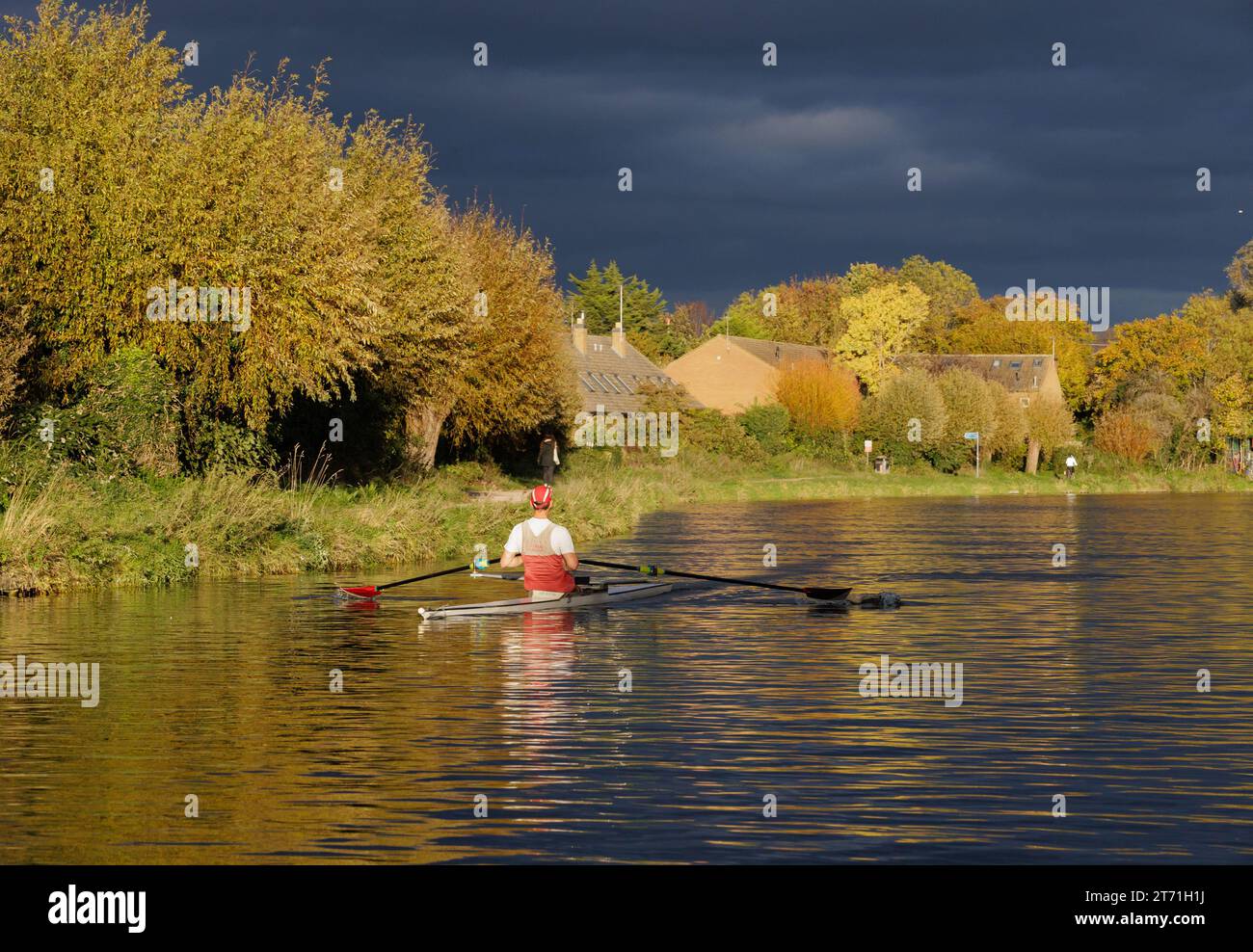 Single rower rowing on Cambridge canal with dark cloudy sky Stock Photo ...