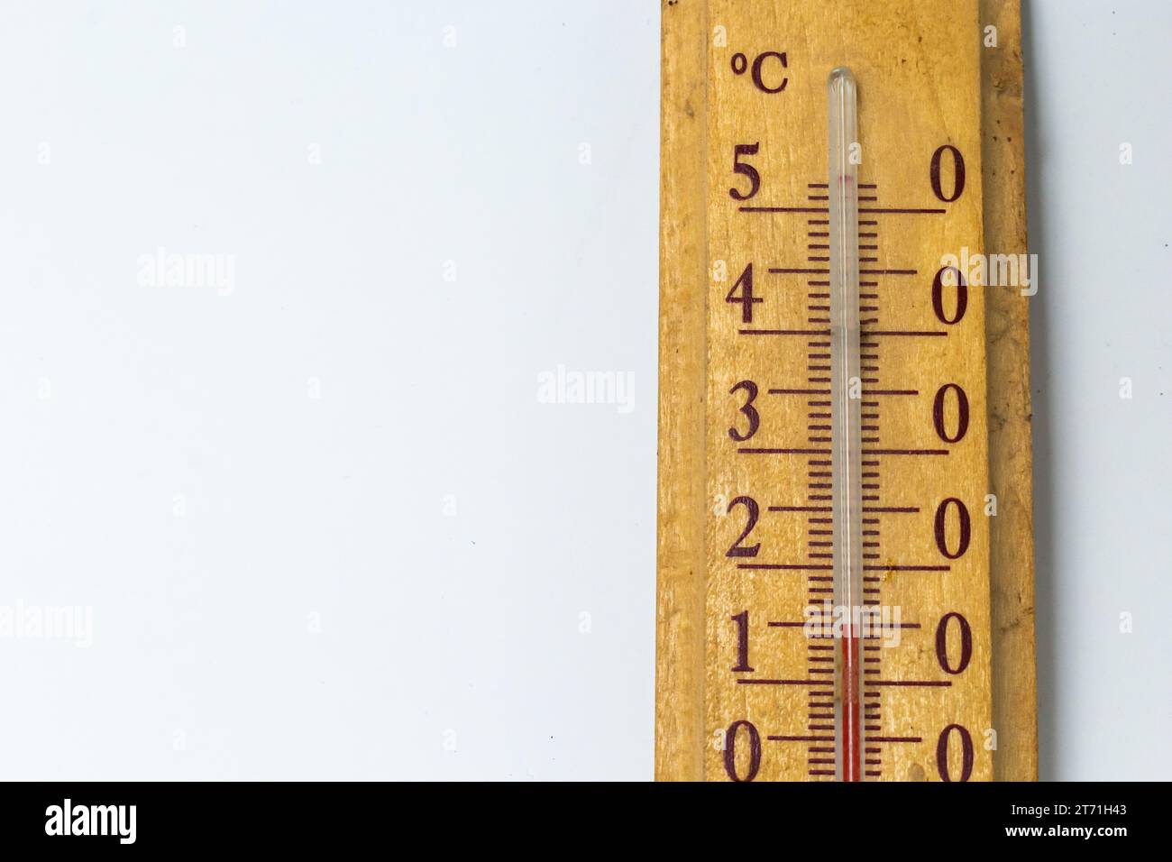 room thermometer on a wooden base close up on a white background ...