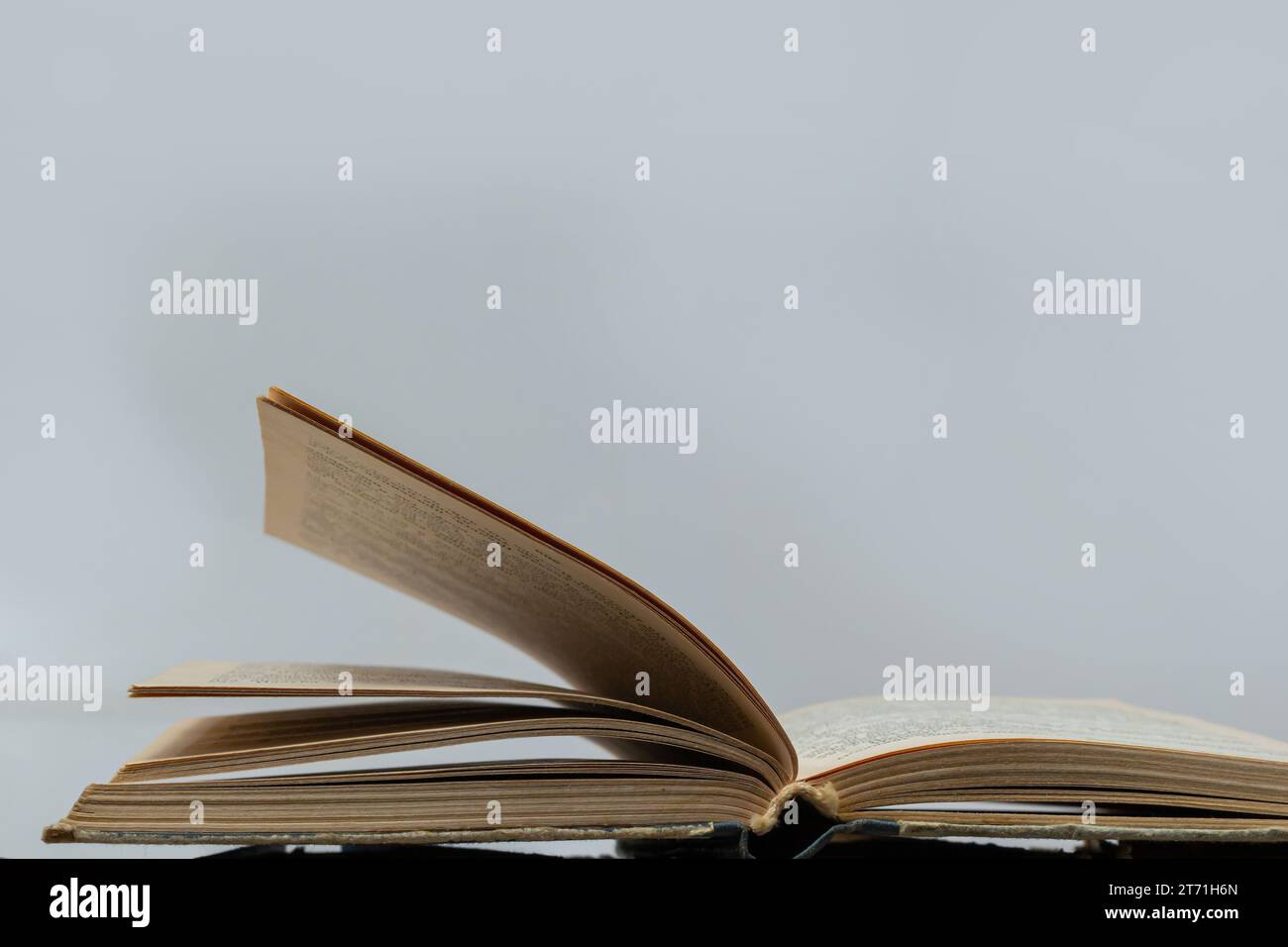 Open old book with text on white background. The concept of reading ...