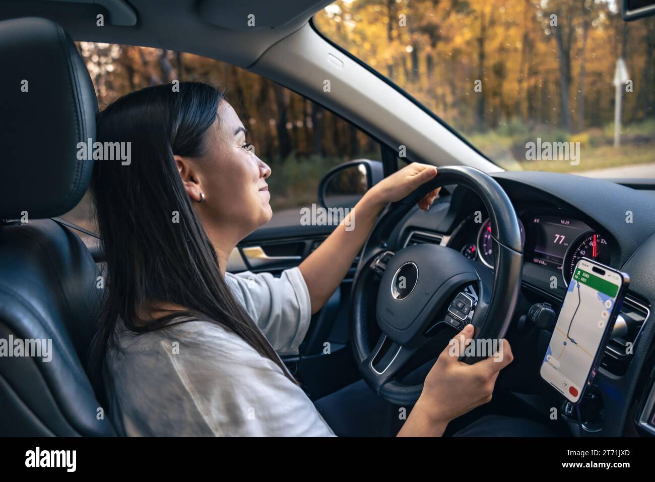 Attractive young woman driving a car, view from inside Stock Photo - Alamy