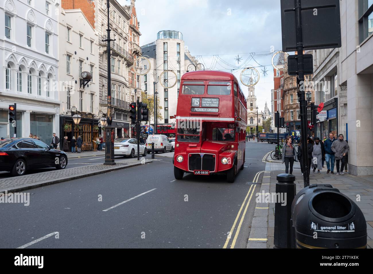Old style red London bus driving along the Strand. November 2023 Stock ...