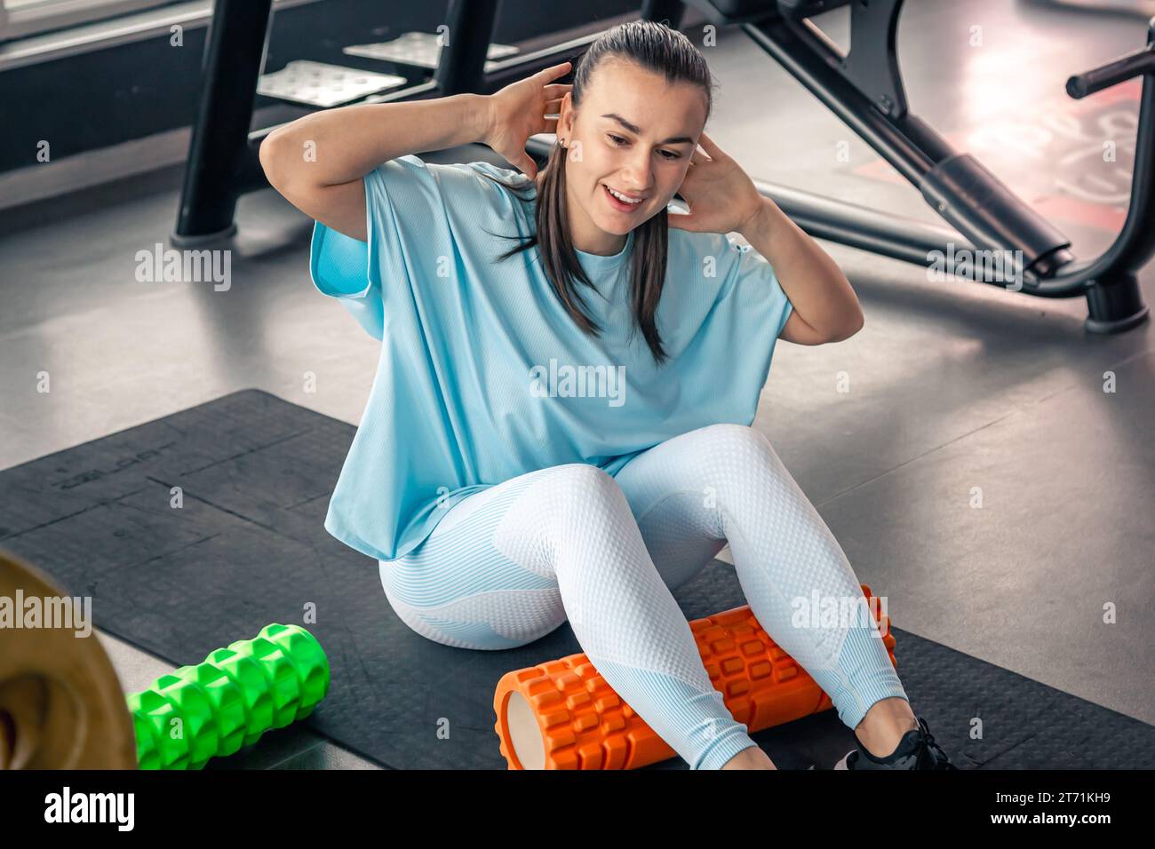 Sport woman using foam roller for muscle and fascia stretching foot ...