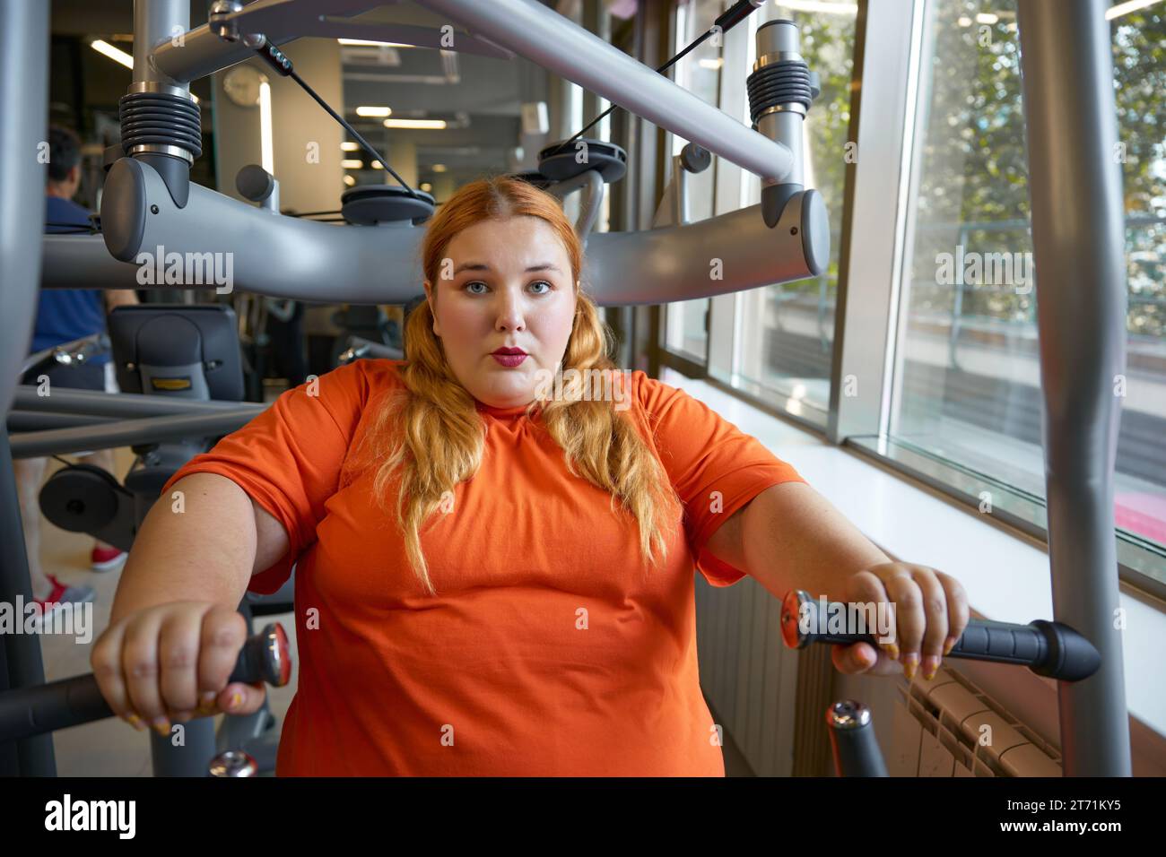 Tired sweaty obese woman breathing hard training at gym Stock Photo - Alamy