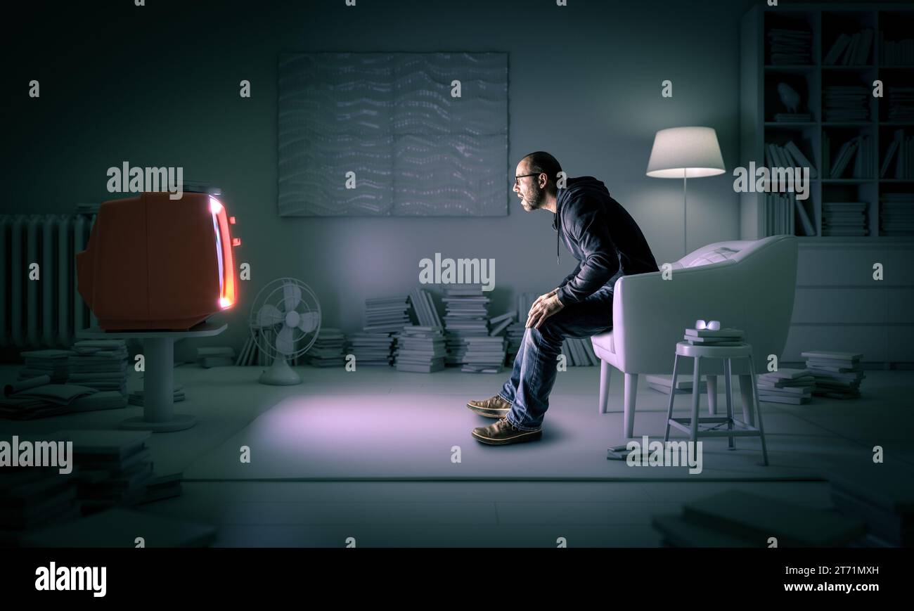 man entranced by television, room full of monochrome books. Concept of ...