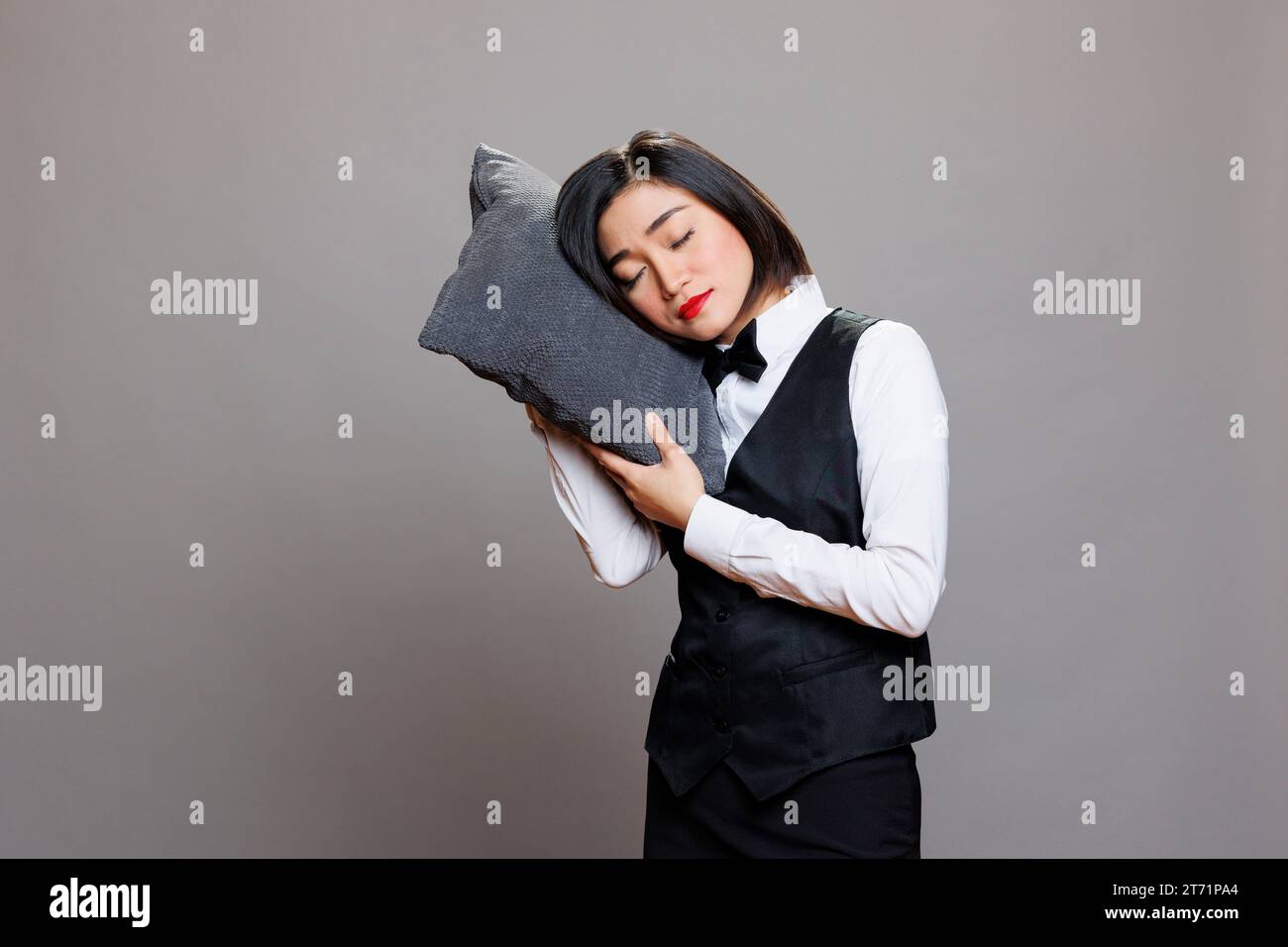 Tired attractive asian waitress wearing restaurant uniform sleeping on ...