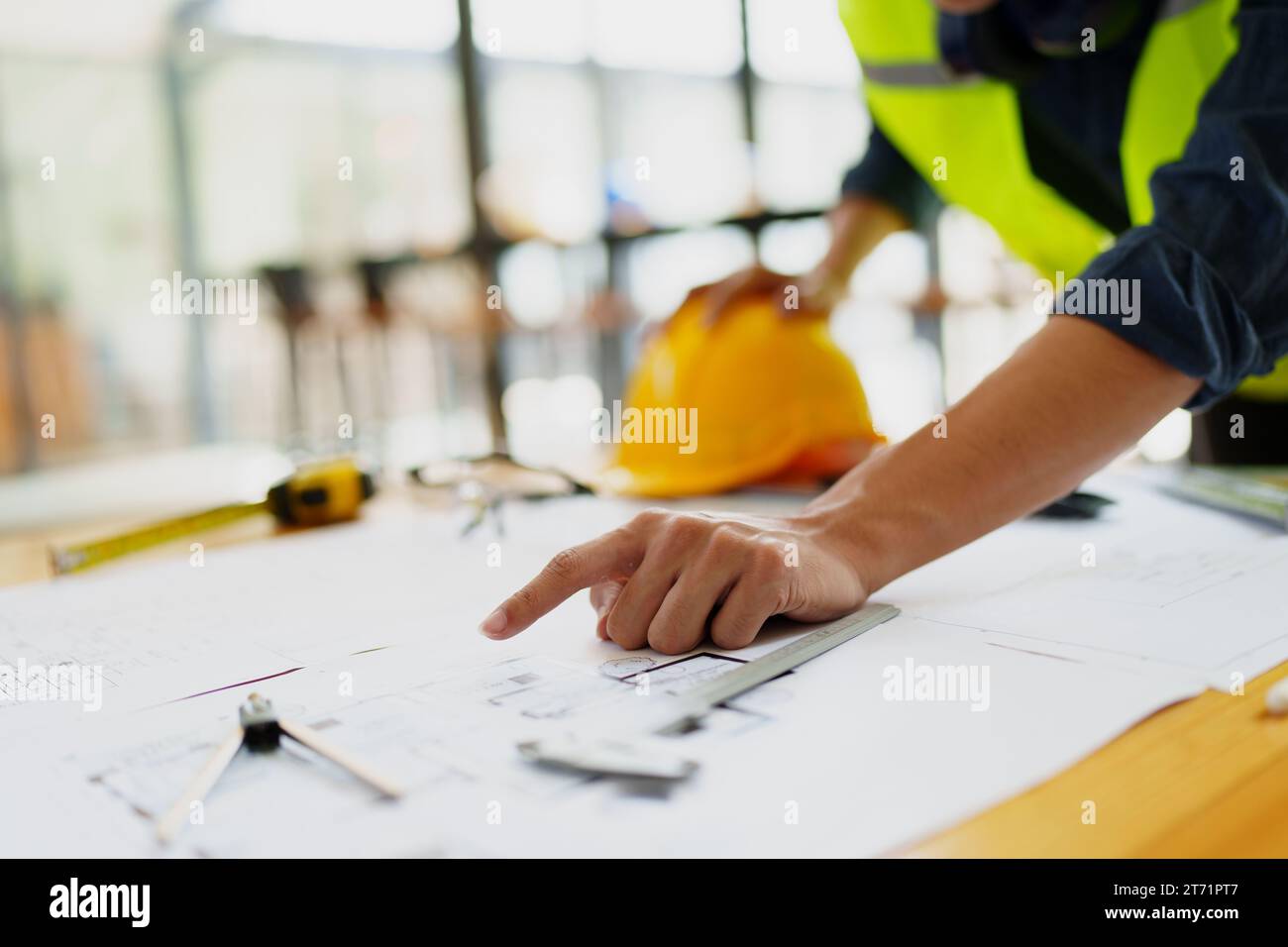 engineers discuss building on blueprint drawing, design building ...