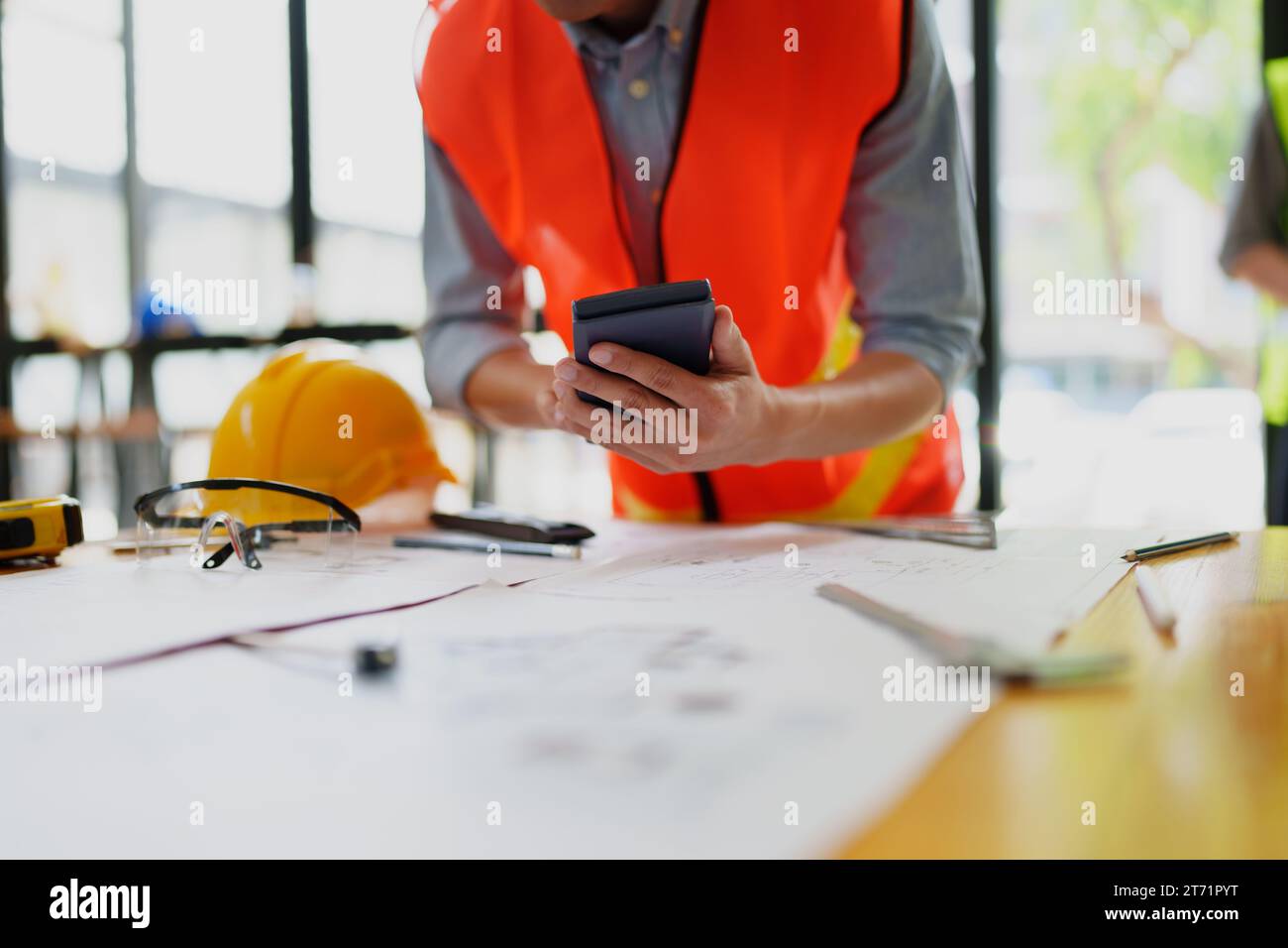 engineers discuss building on blueprint drawing using calculator Stock ...
