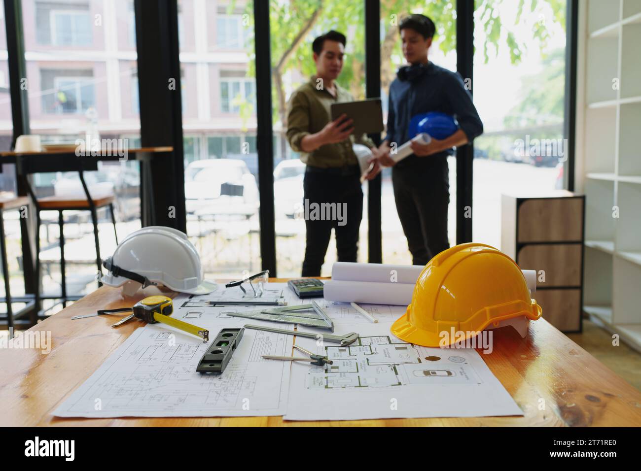 engineers discuss building on blueprint drawing, design building ...