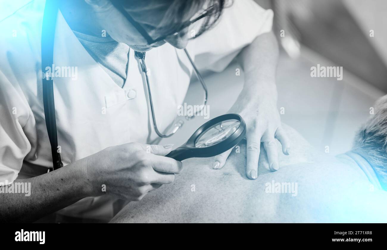 Dermatologist examining the skin on the back of a patient; light effect ...