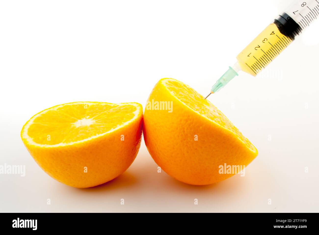 detail of a injection and a orange; detail of a injection and a orange ...