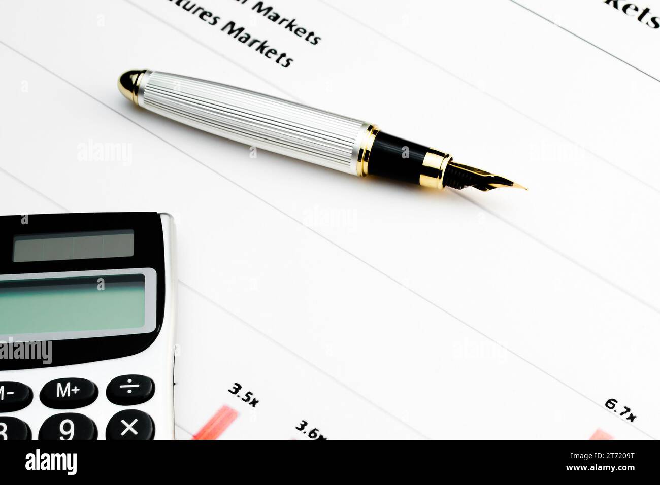detail of calculator and pen on financial chart Stock Photo - Alamy