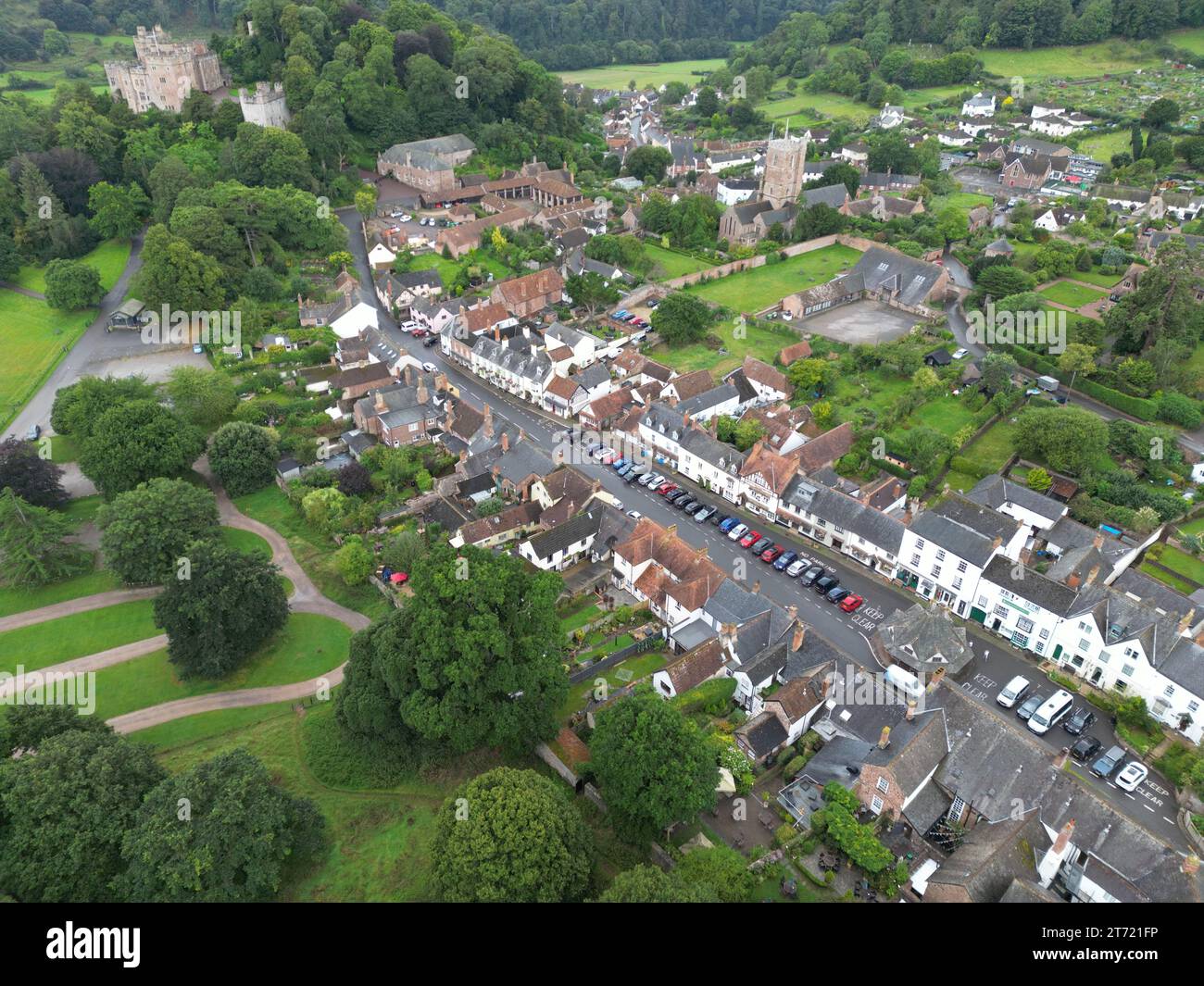 Aerial drone view of Dunster Castle and historic village of Dunster ...