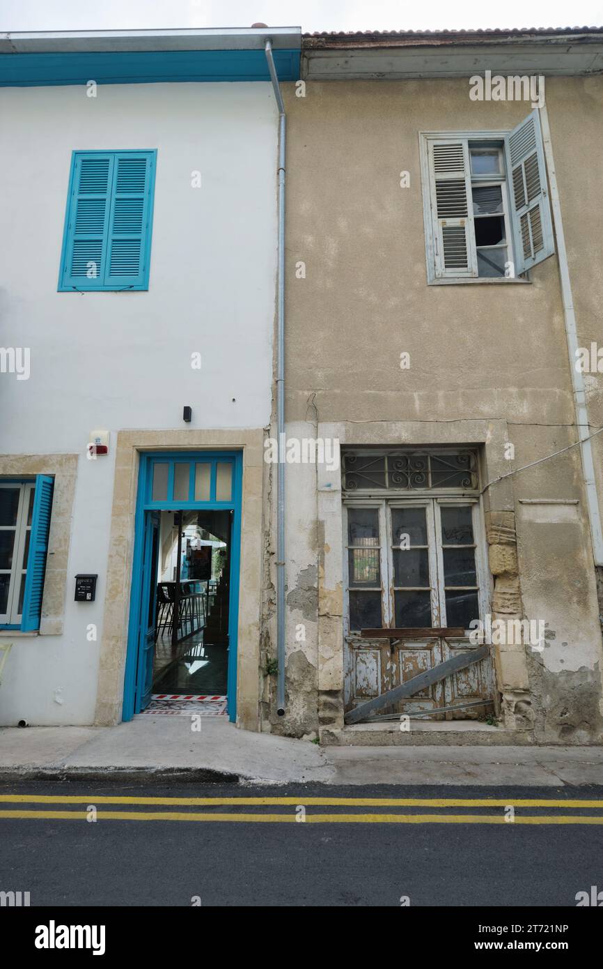 Refurbished building next to a derelict building in downtown Larnaca ...