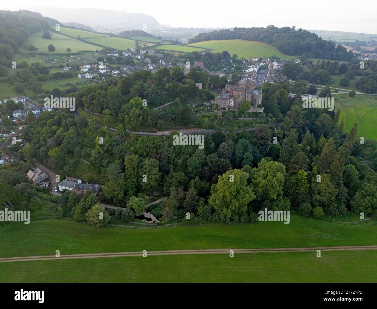 Aerial drone view of Dunster Castle and historic village of Dunster ...