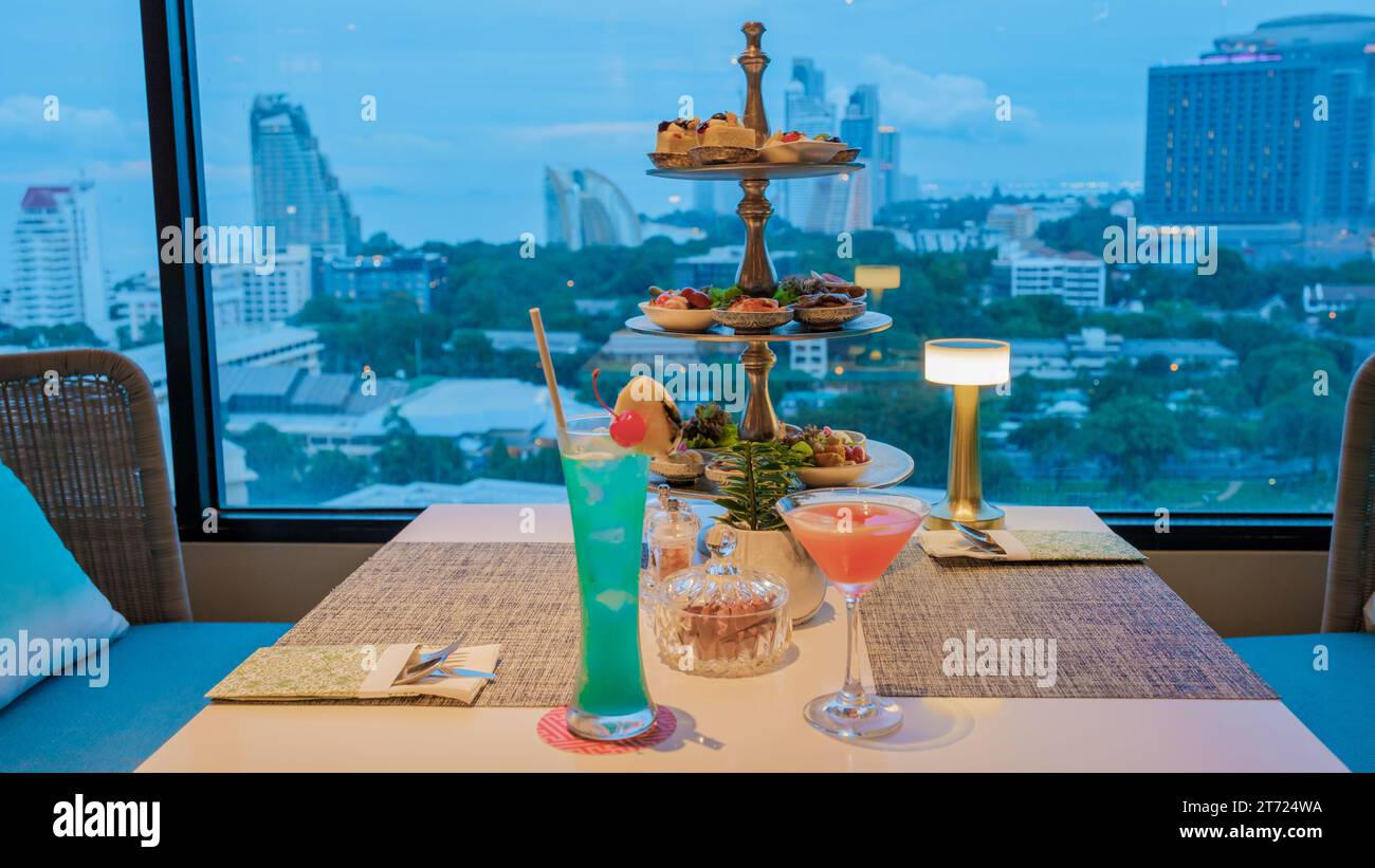rooftop bar in Pattaya Thailand with cocktails and snacks by the window ...
