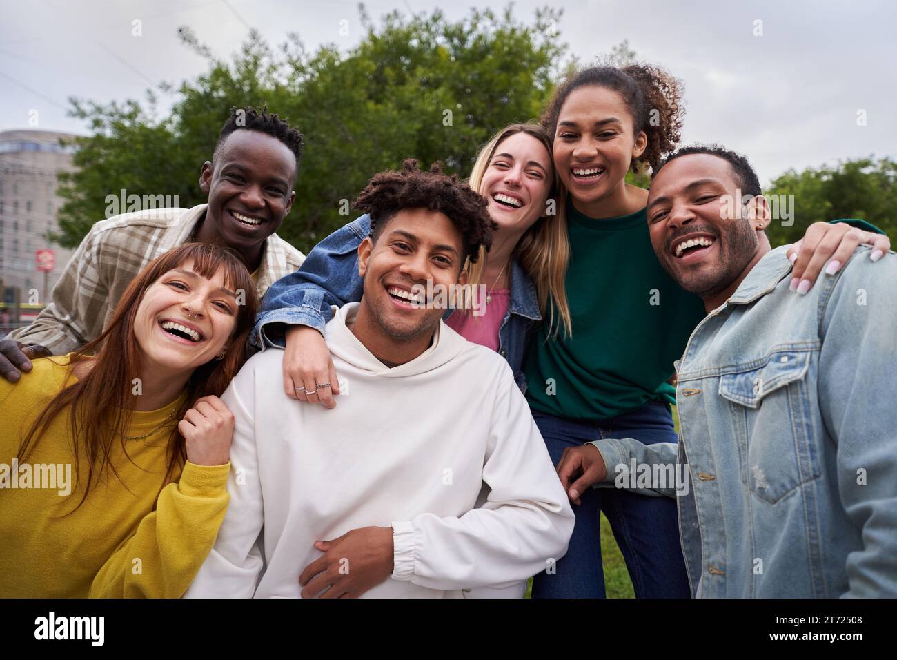 Multiracial group of friends outdoors smiling and having fun ...