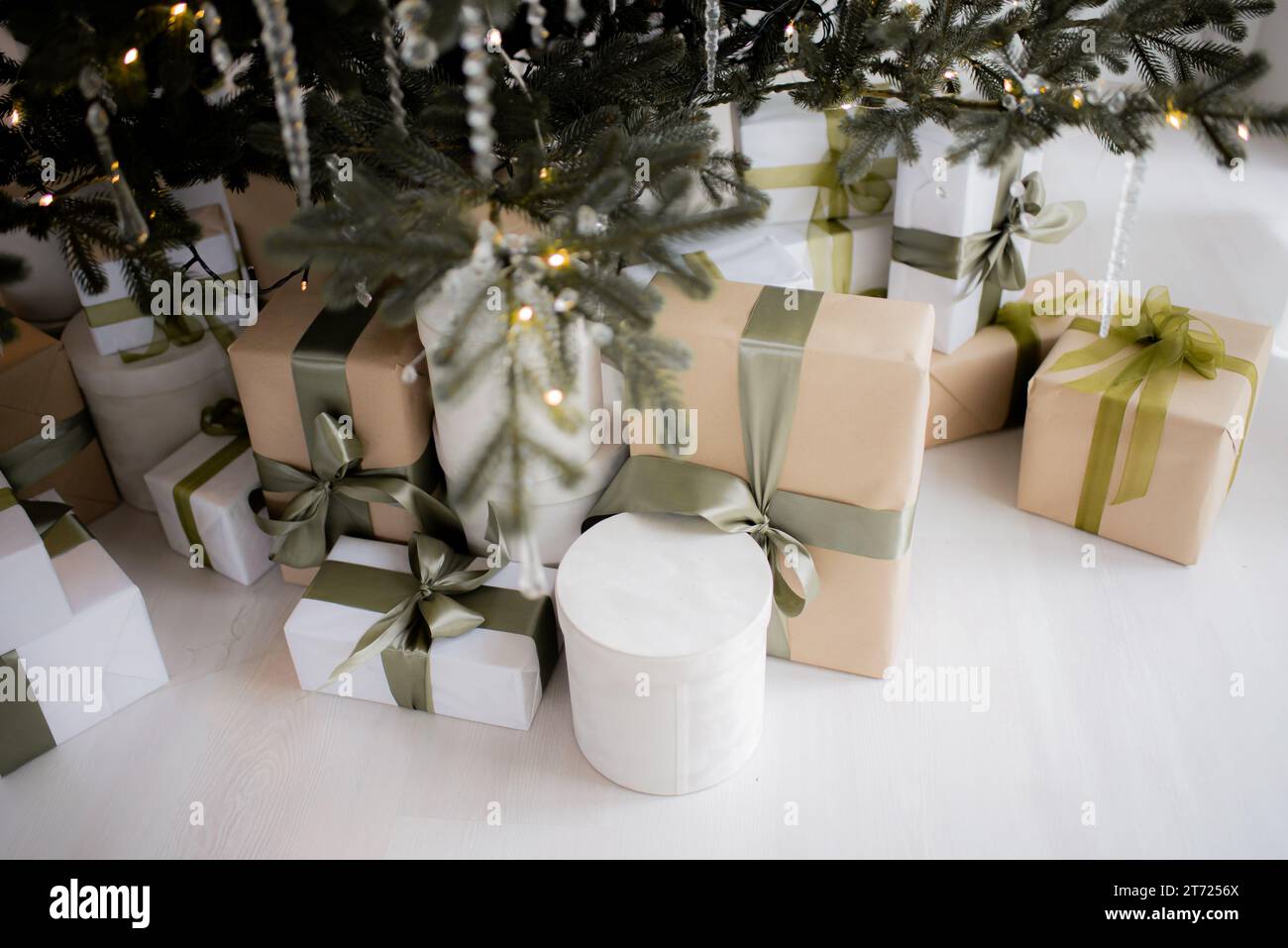 Christmas boxes with gifts under the tree Stock Photo - Alamy