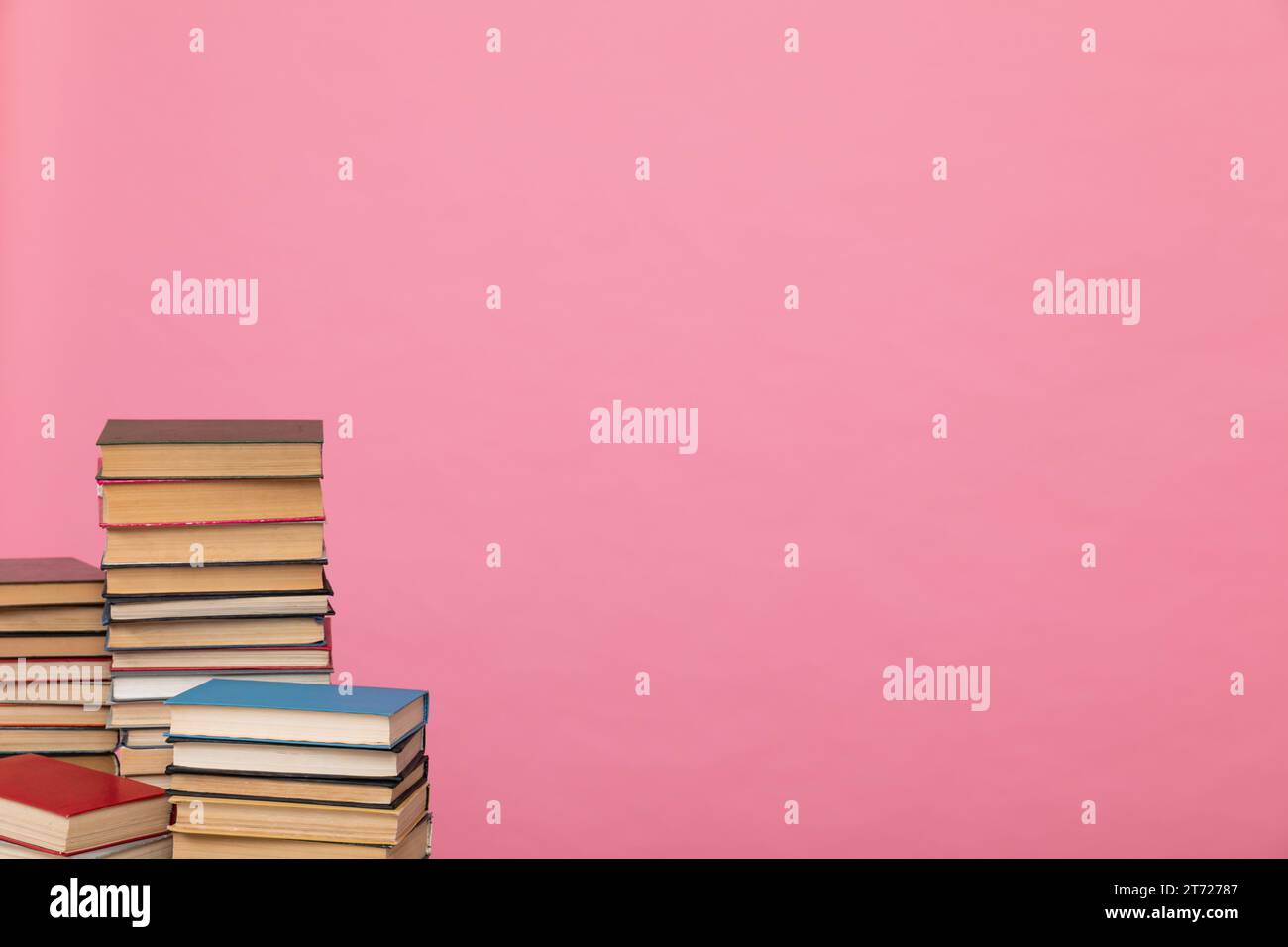 stack of books on a pink background in the learning library Stock Photo ...