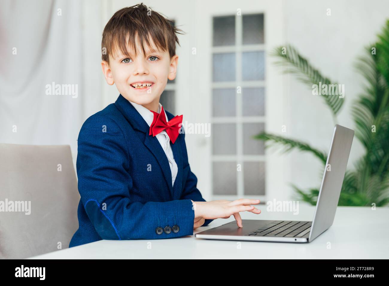 boy at the computer in the classroom learning online Stock Photo - Alamy