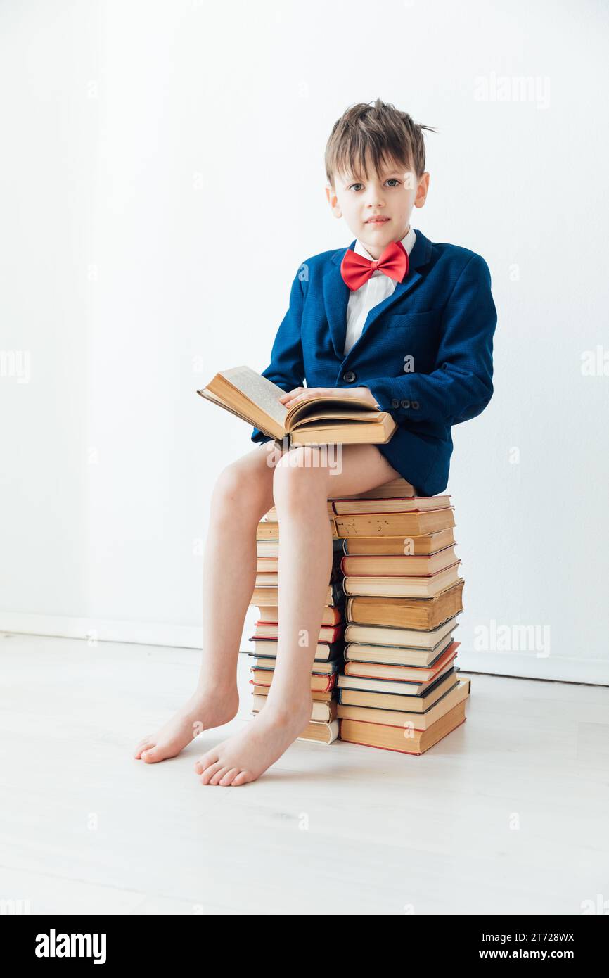 important boy sitting on books teaching school class Stock Photo - Alamy