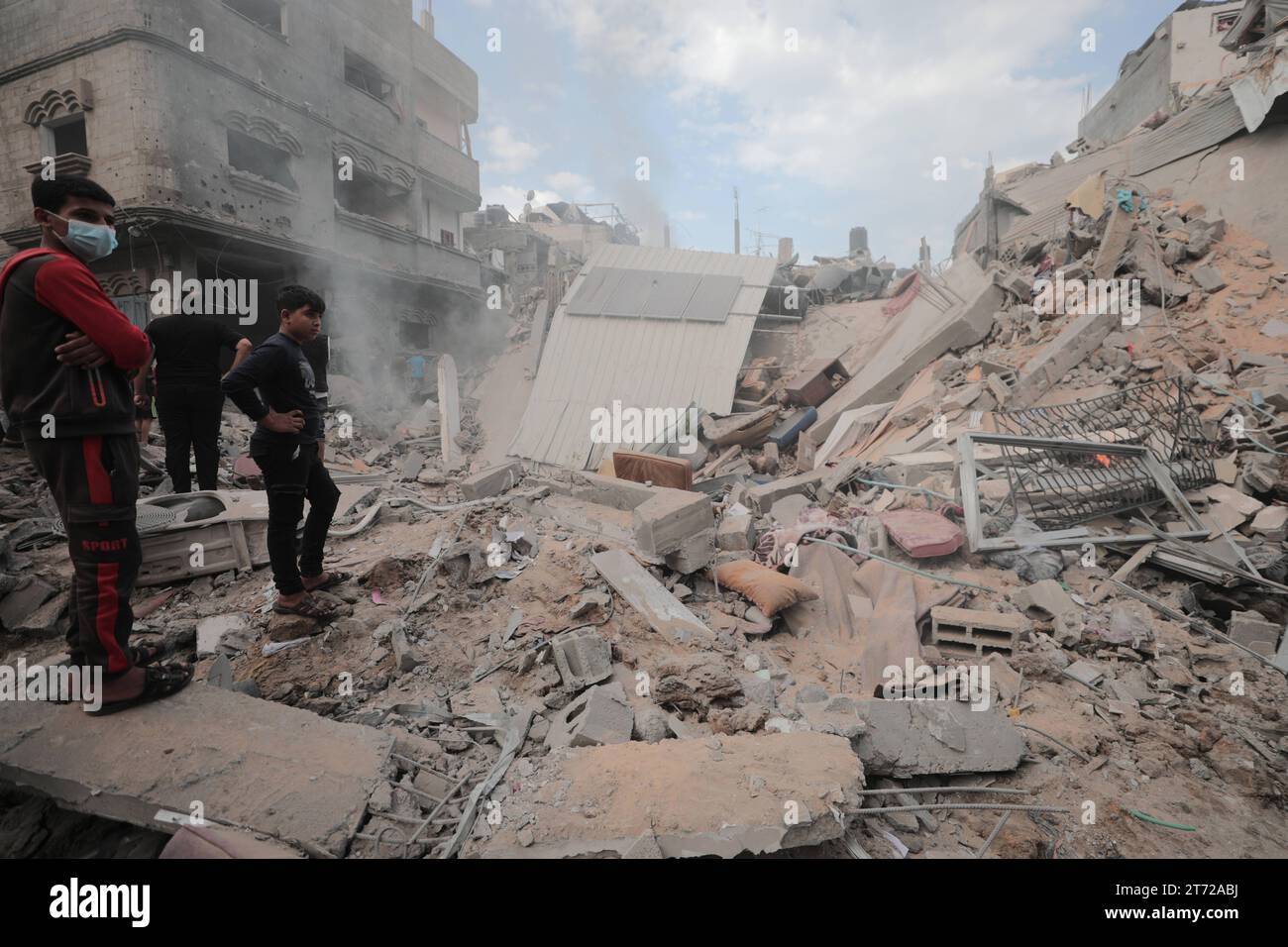 Palestinians inspect the destroyed house of Ghanem family, following an ...