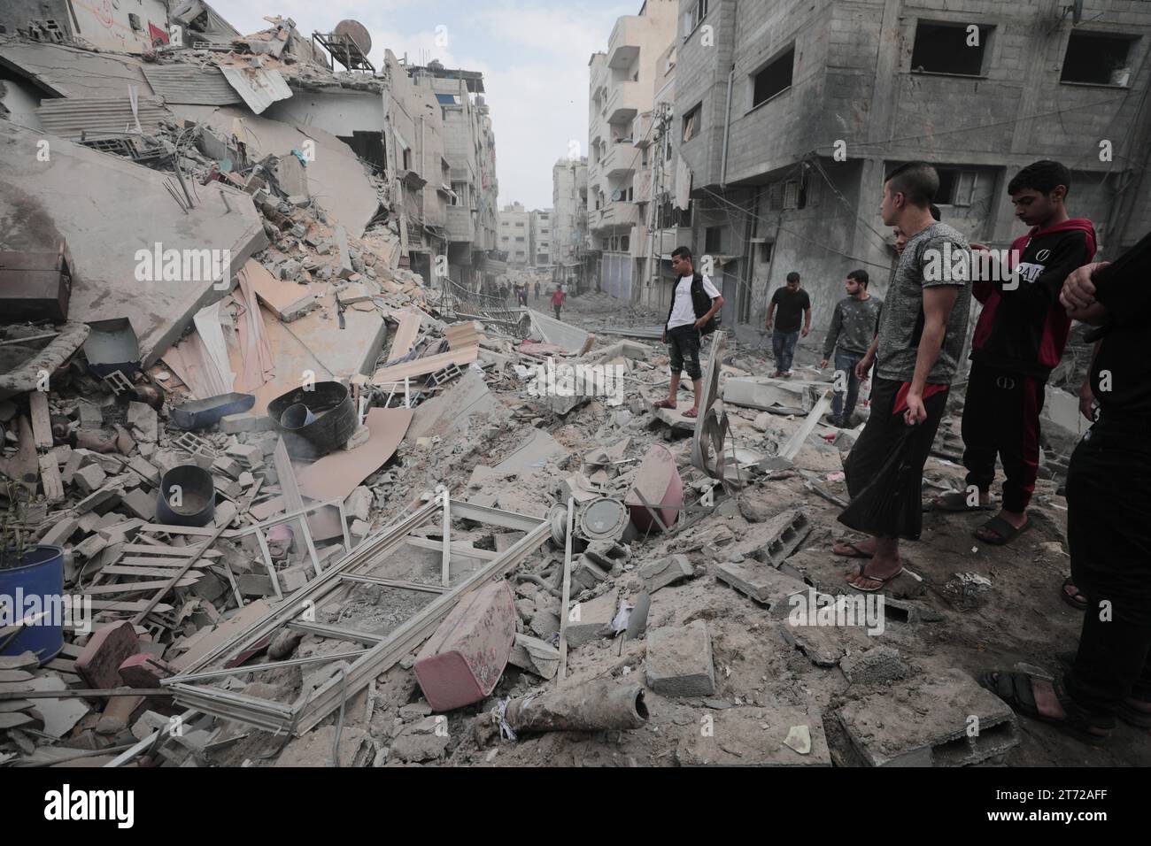 Palestinians inspect the destroyed house of Ghanem family, following an ...