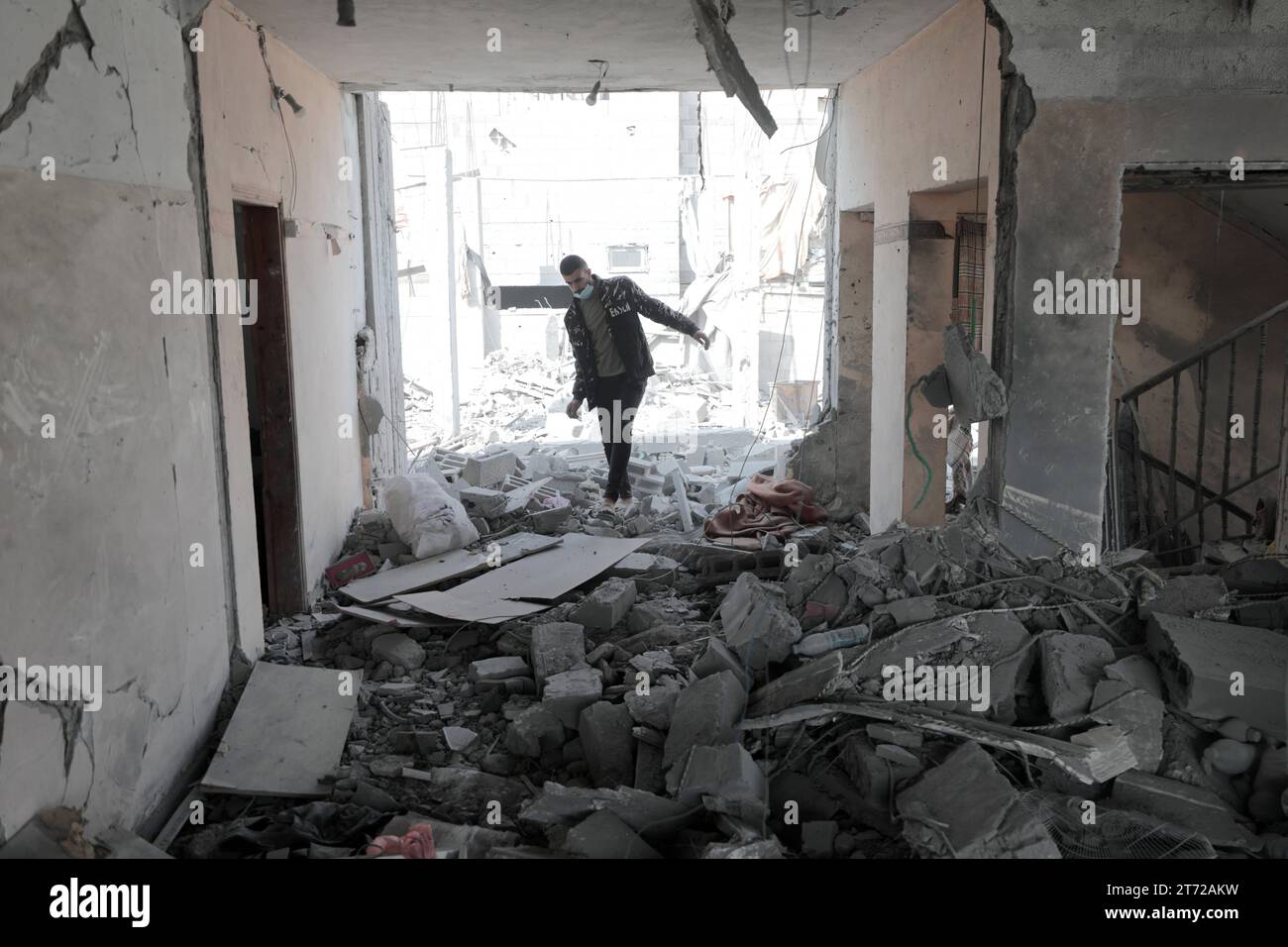 Palestinians inspect the destroyed house of Ghanem family, following an ...