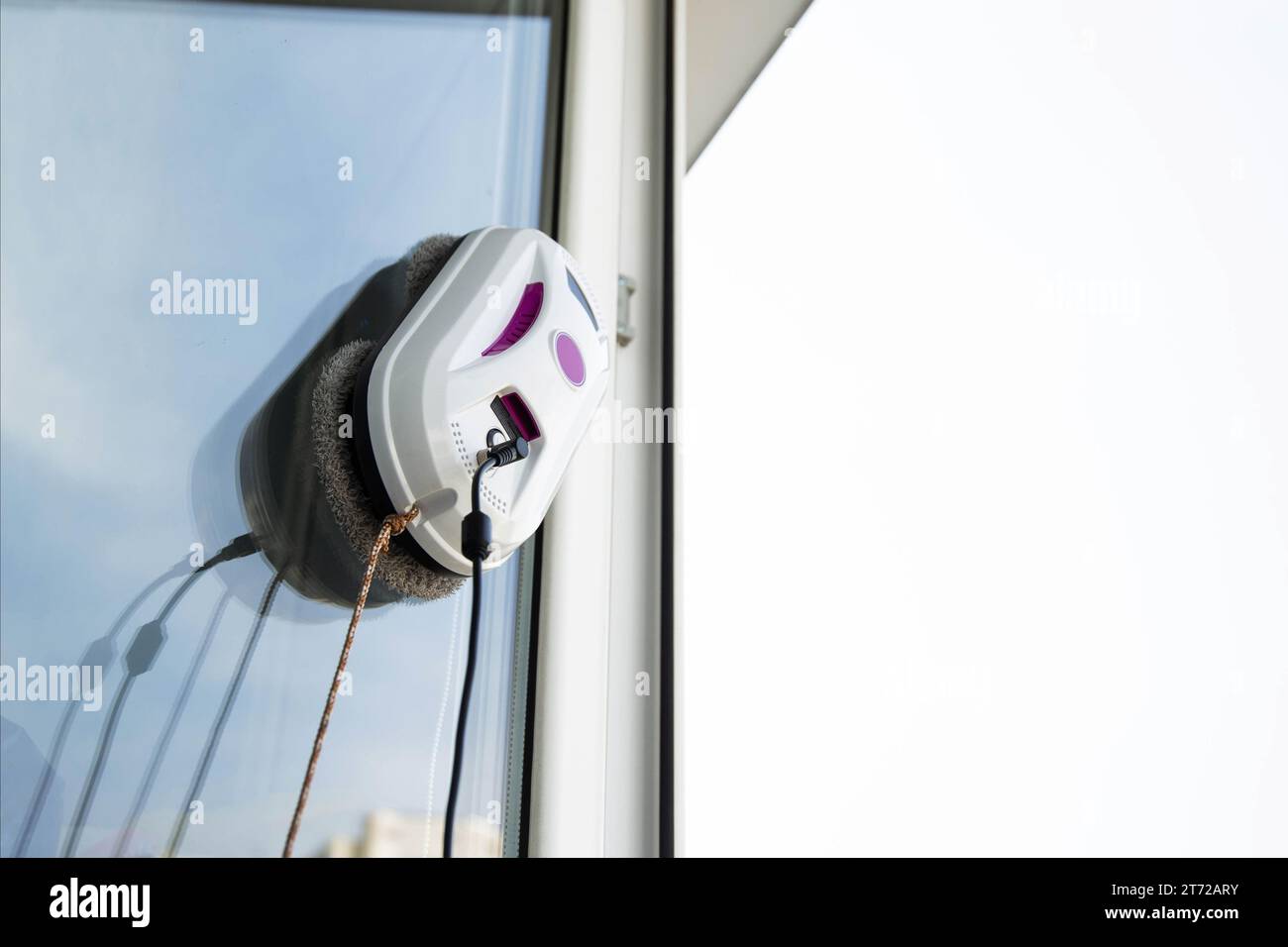 Automatic vacuum robot window cleaner washes glass in the apartment ...