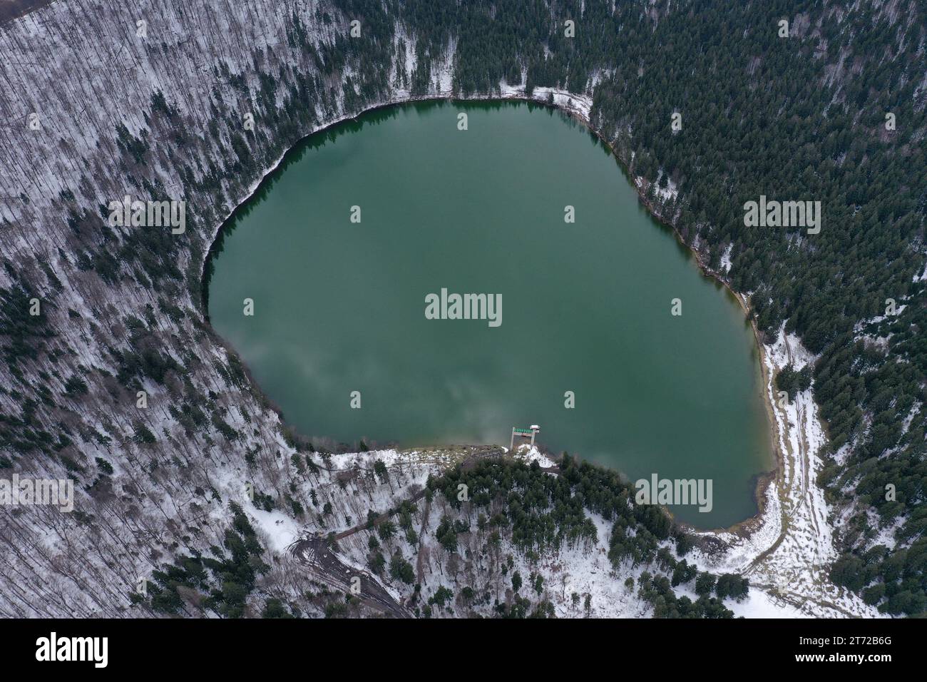 Aerial drone view of a volcanic crater lake at winter. Flying above ...