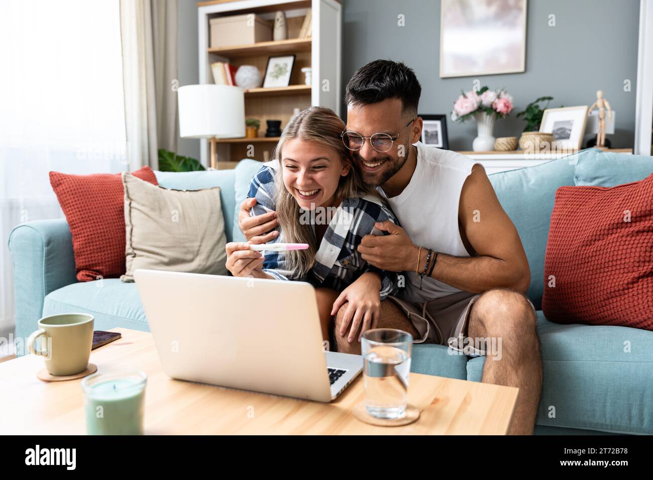 Happy future parents using laptop hi-res stock photography and images ...
