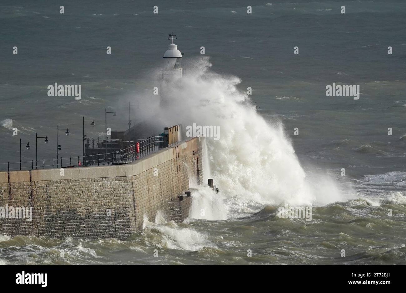 Waves crash over the harbour arm in Folkestone, Kent. Amber weather ...