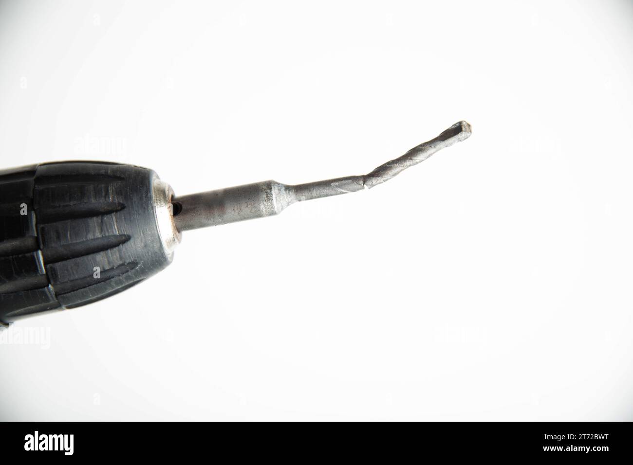 Poor quality broken metal drill on a white background Stock Photo - Alamy