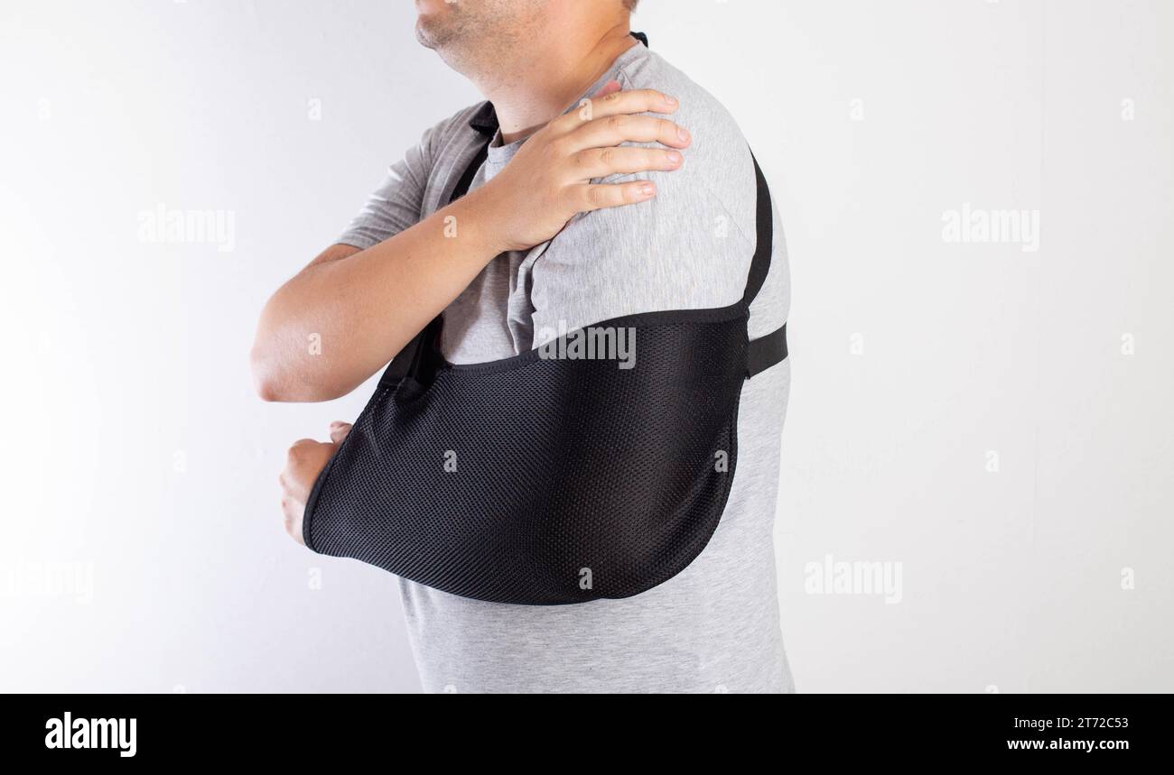 A man's arm in a black bandage for immobilization of the elbow joint ...