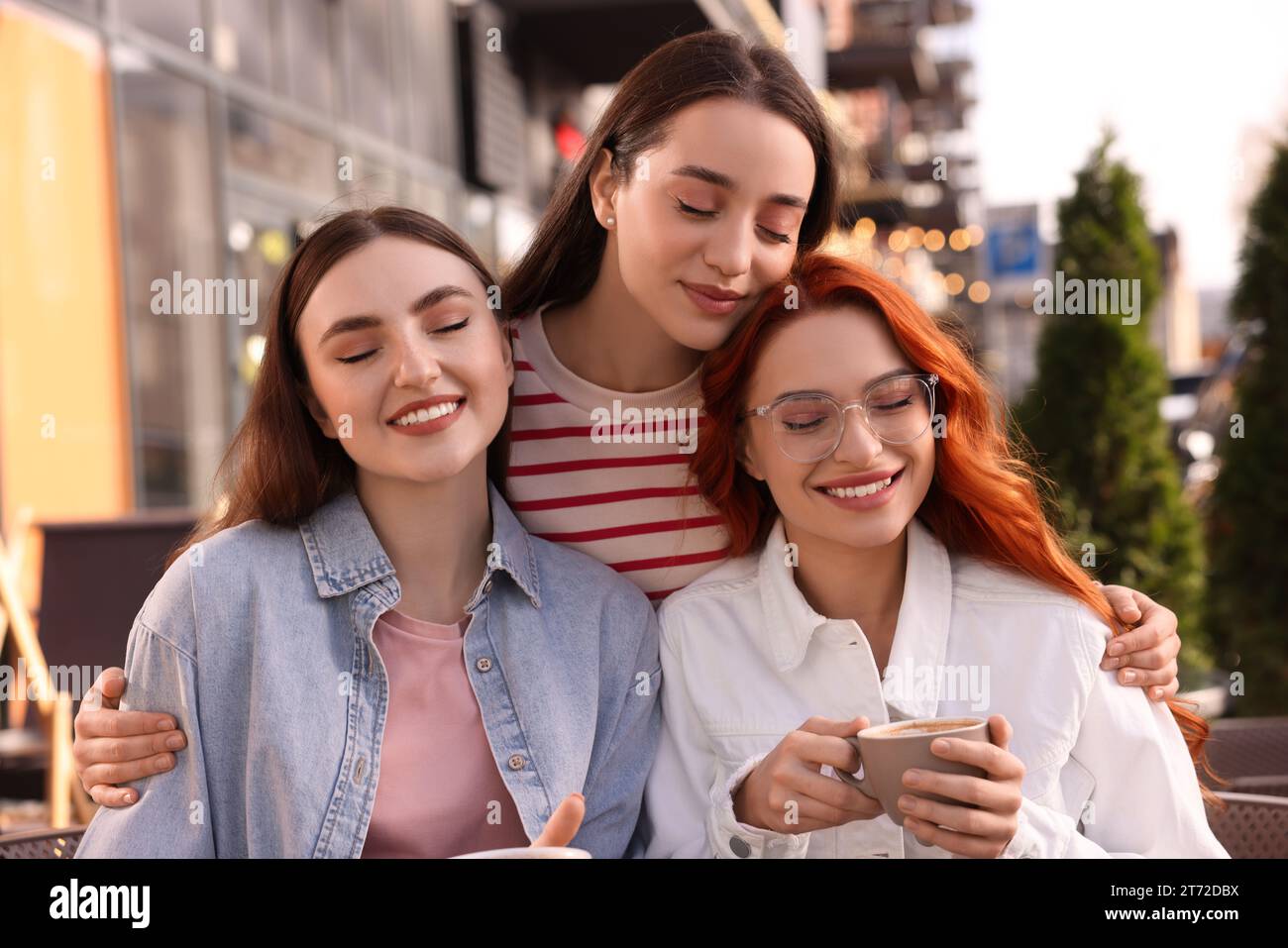 Happy friends spending time together in outdoor cafe Stock Photo - Alamy
