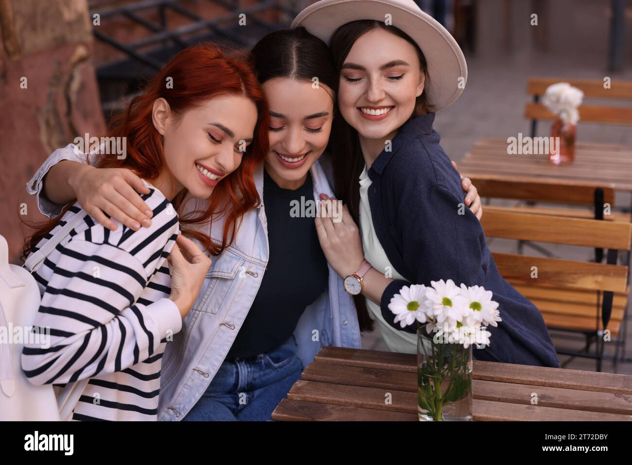 Happy friends spending time together in outdoor cafe Stock Photo - Alamy