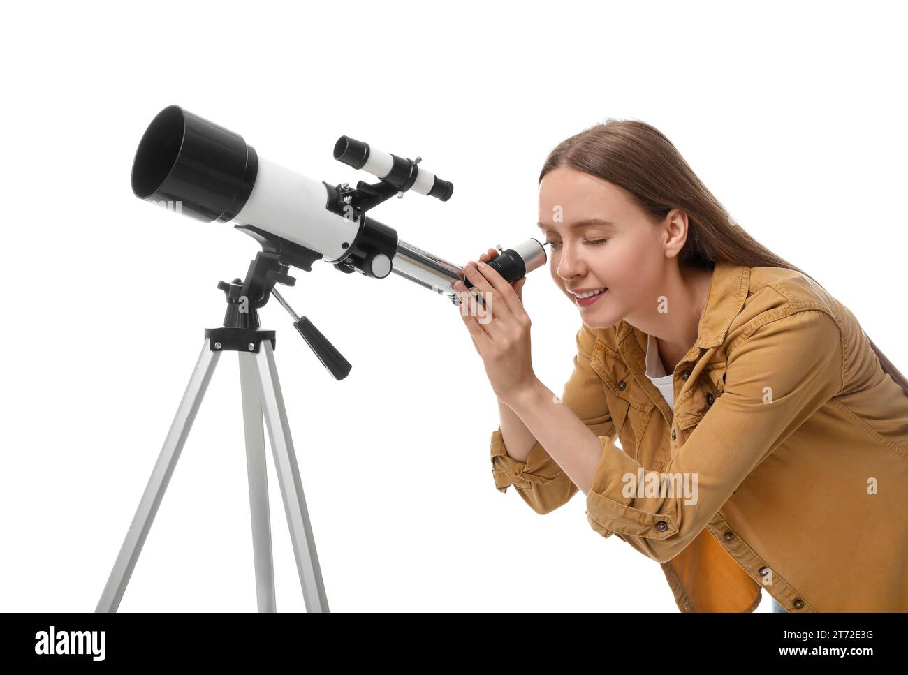 Young astronomer looking at stars through telescope on white background ...