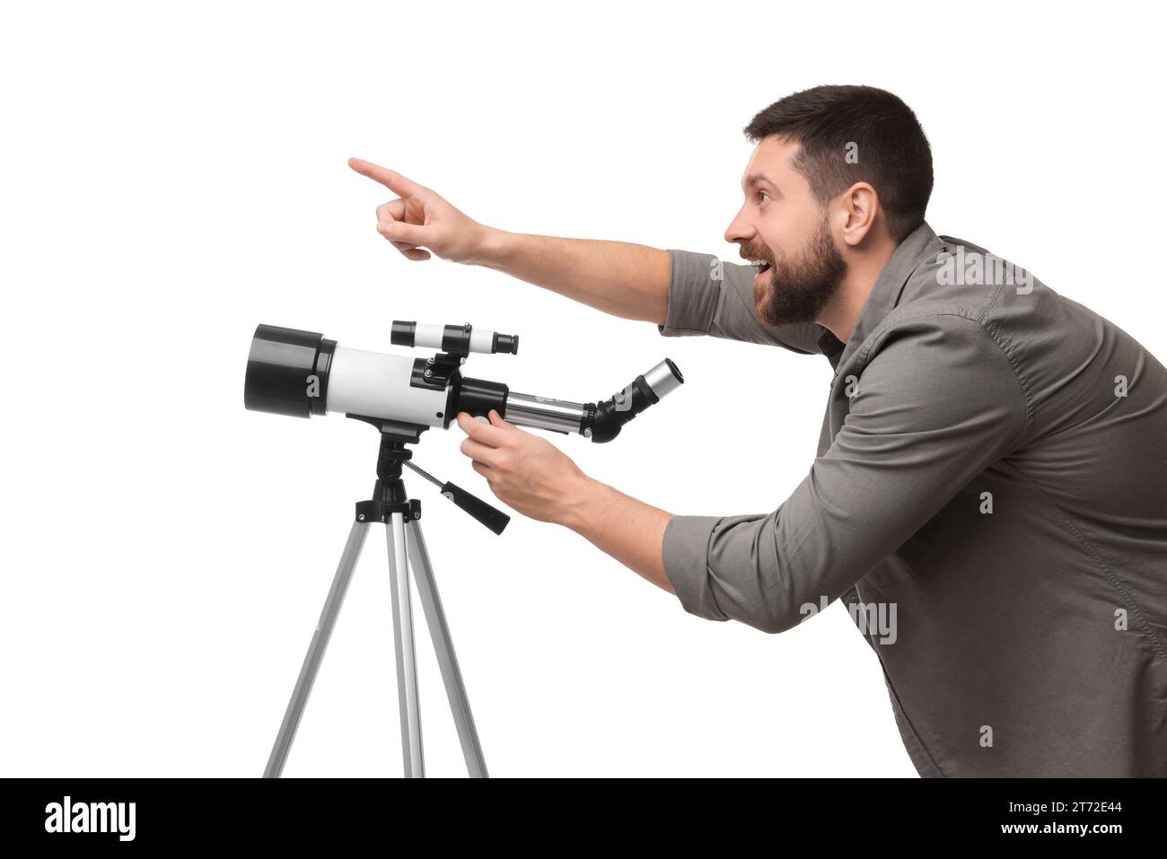 Excited astronomer with telescope pointing at something on white ...