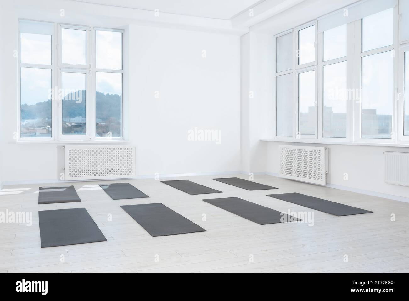 Spacious yoga studio with exercise mats and big windows Stock Photo - Alamy