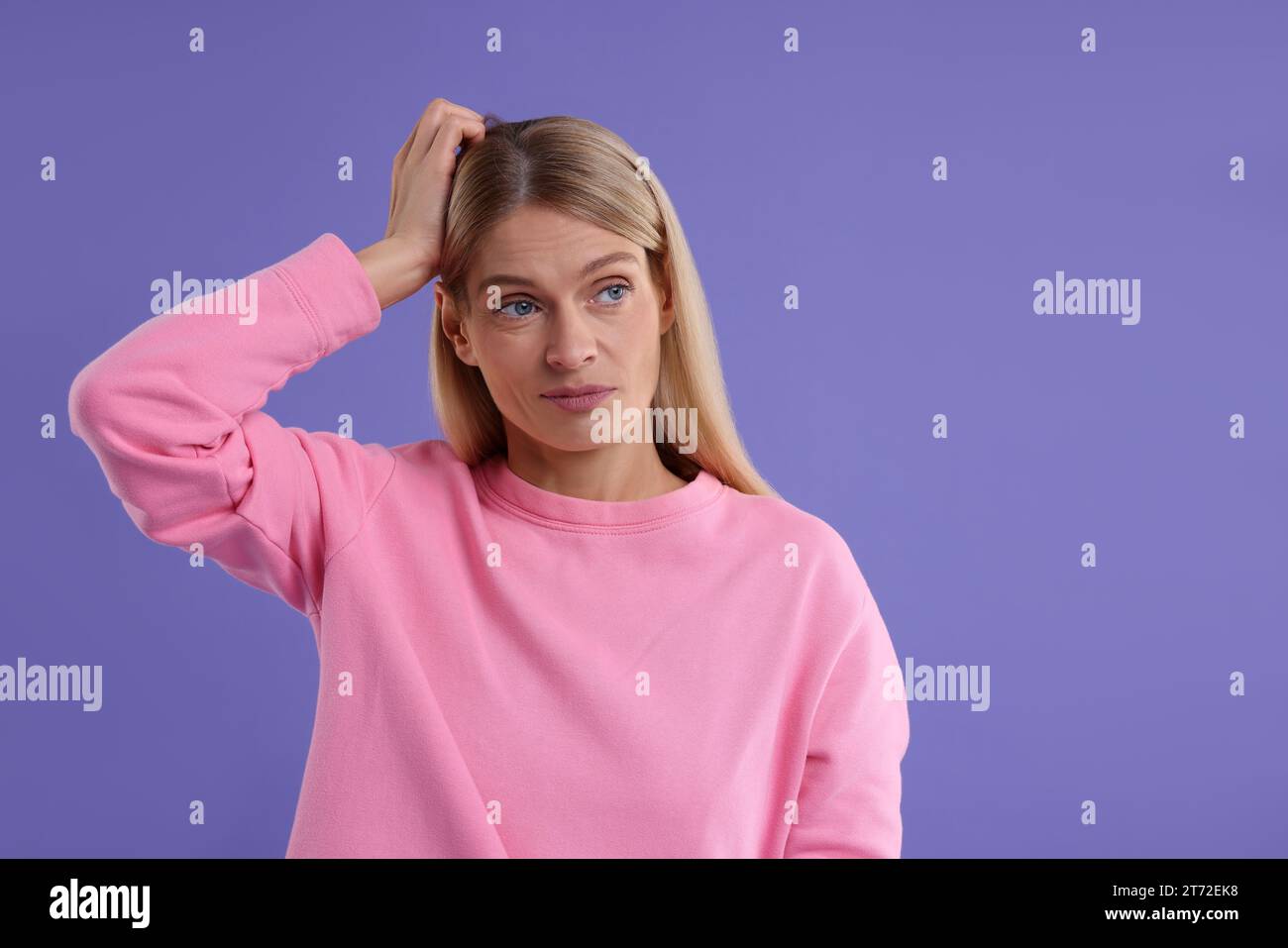 Portrait of embarrassed woman on purple background Stock Photo - Alamy
