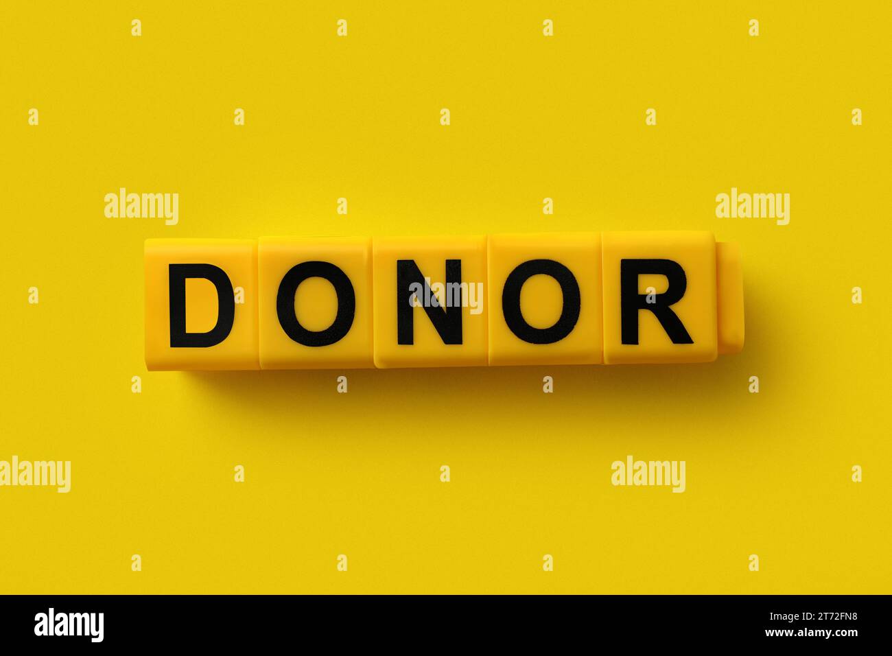 Word Donor made of cubes on yellow background, top view Stock Photo - Alamy