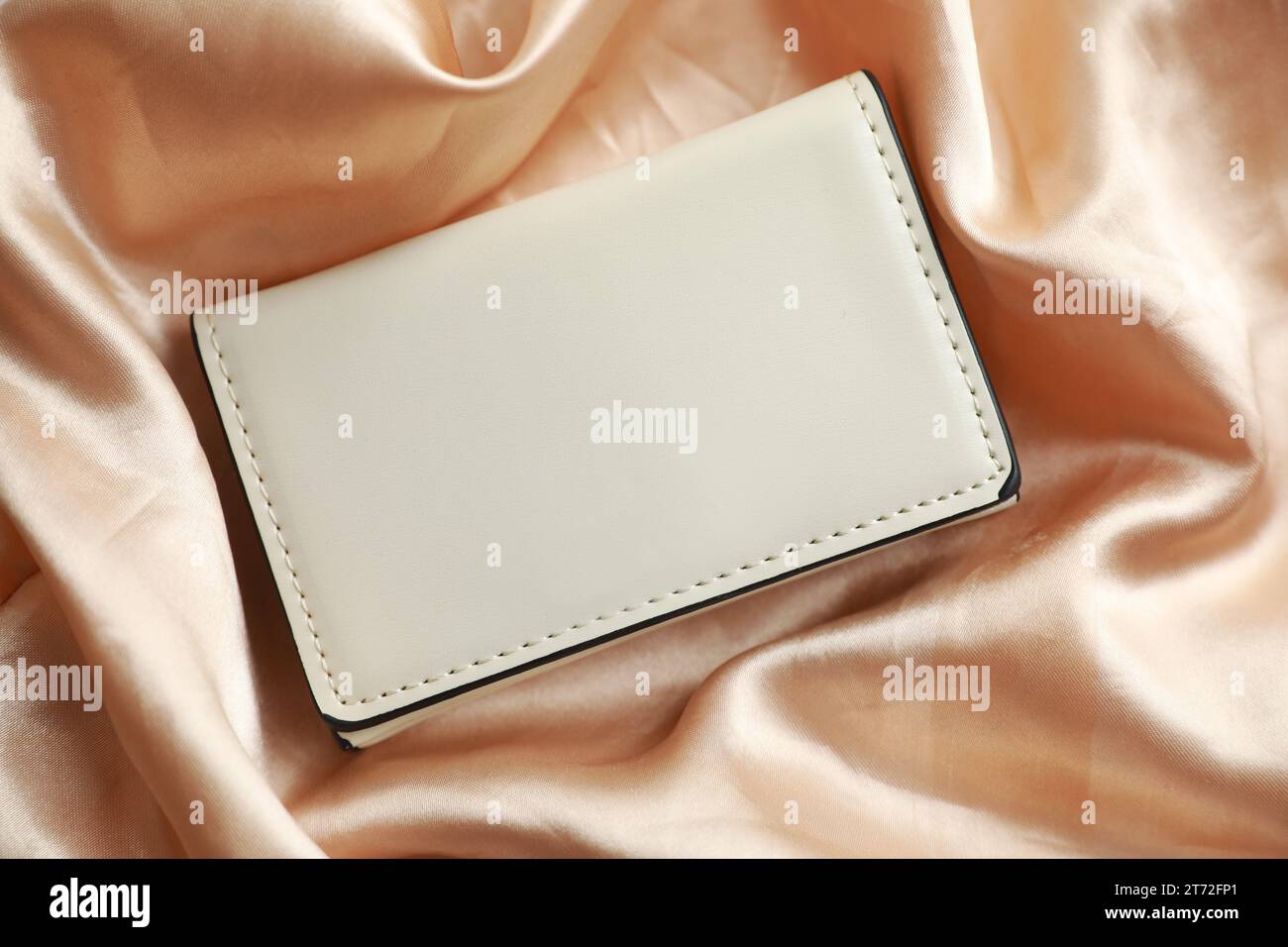 Stylish presentation of leather purse on silk fabric, top view Stock ...